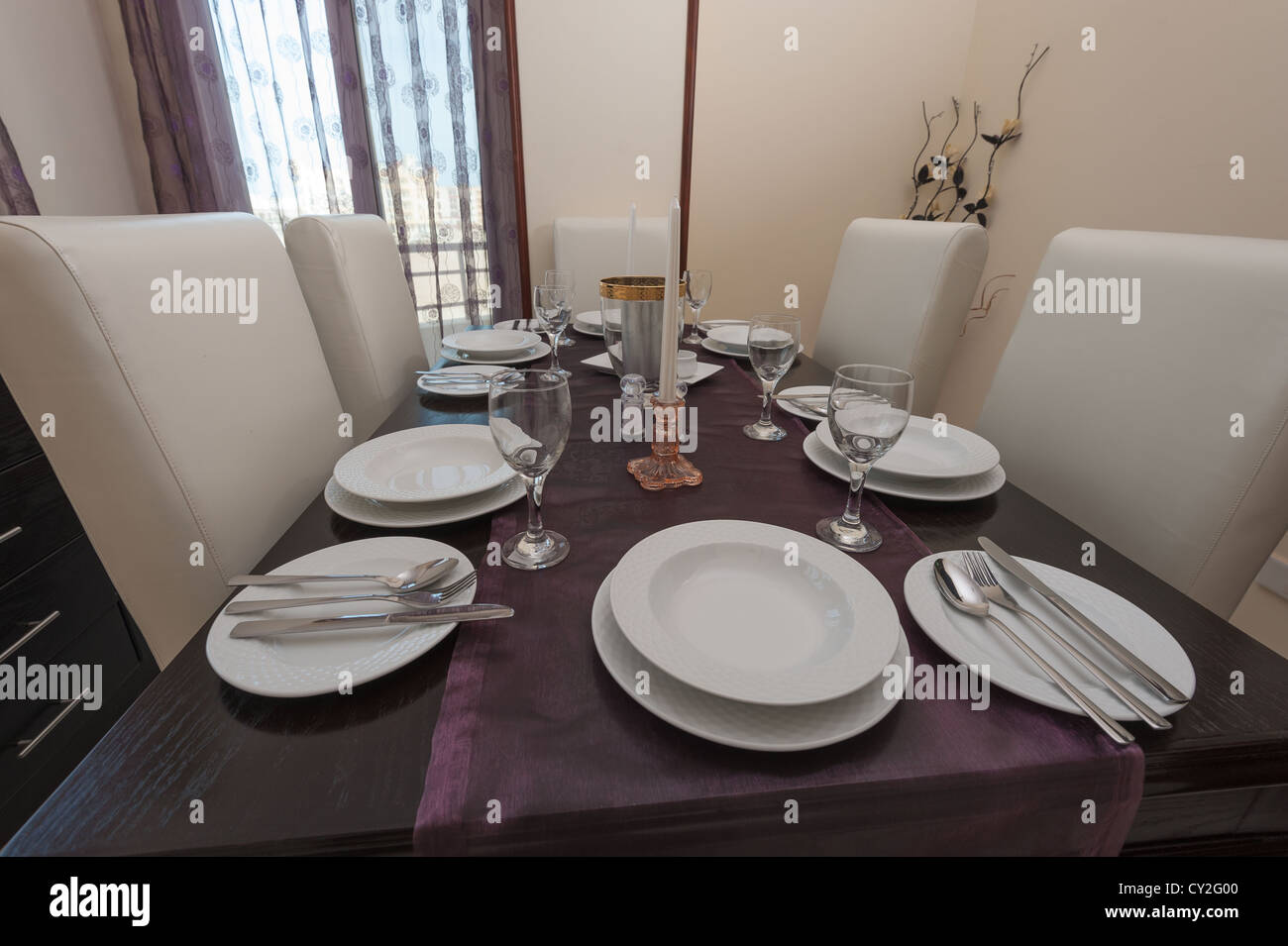 Dining room with table and settings in a luxury apartment Stock Photo ...