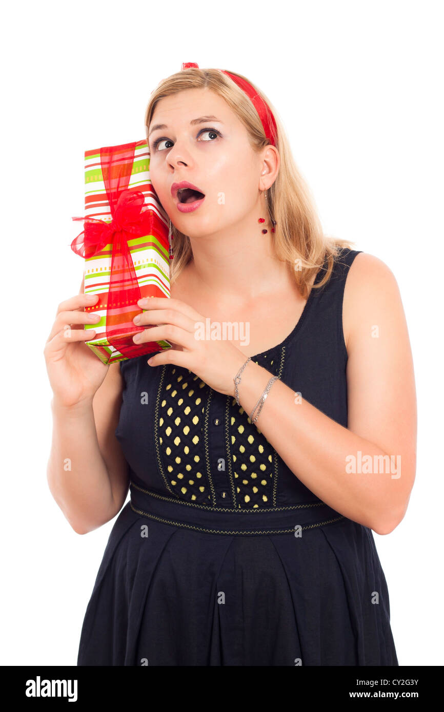 Curious woman holding exploring gift box, isolated on white background ...