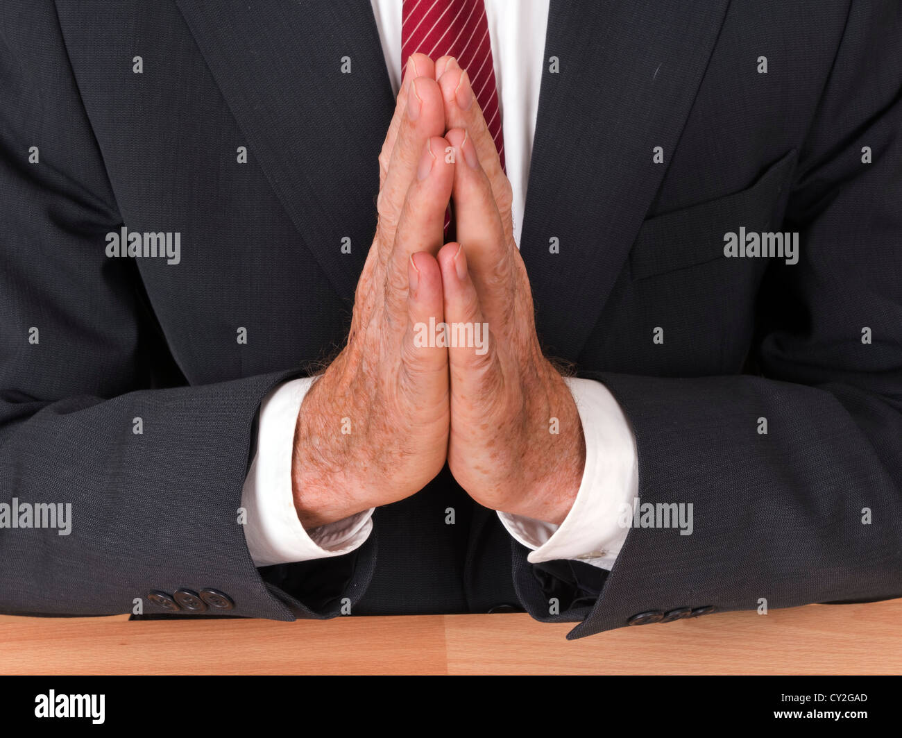 Business man at prayer, at desk Stock Photo - Alamy
