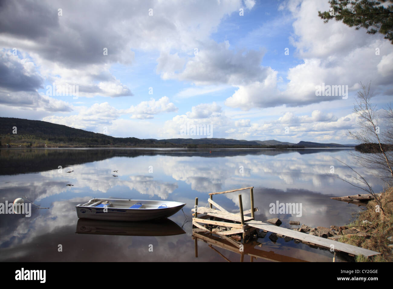 A rowing boat lies on the banks of the Swedish river Angermanaelv in ...