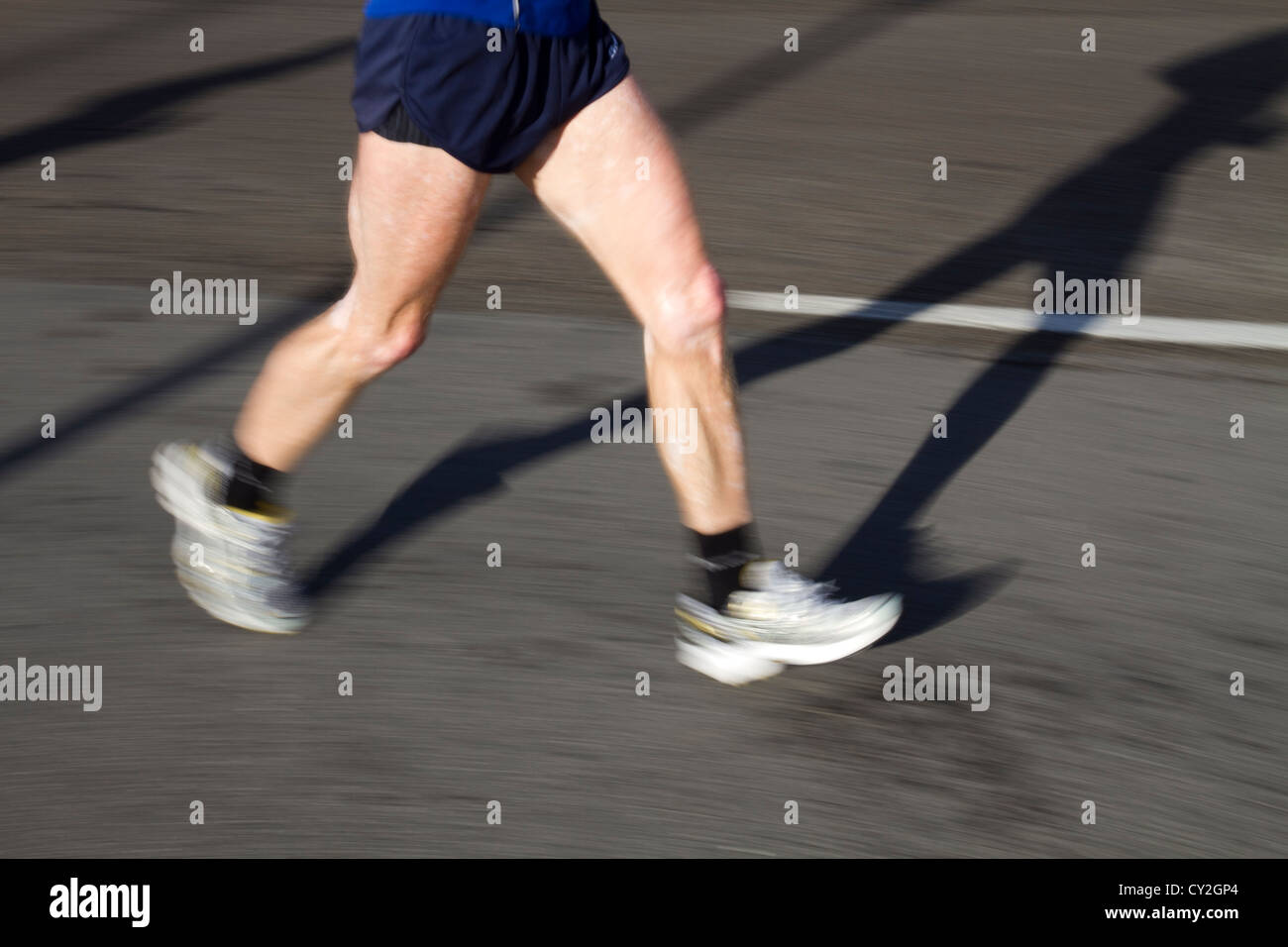 runner legs athlete Marathon running shadow on road Stock Photo - Alamy