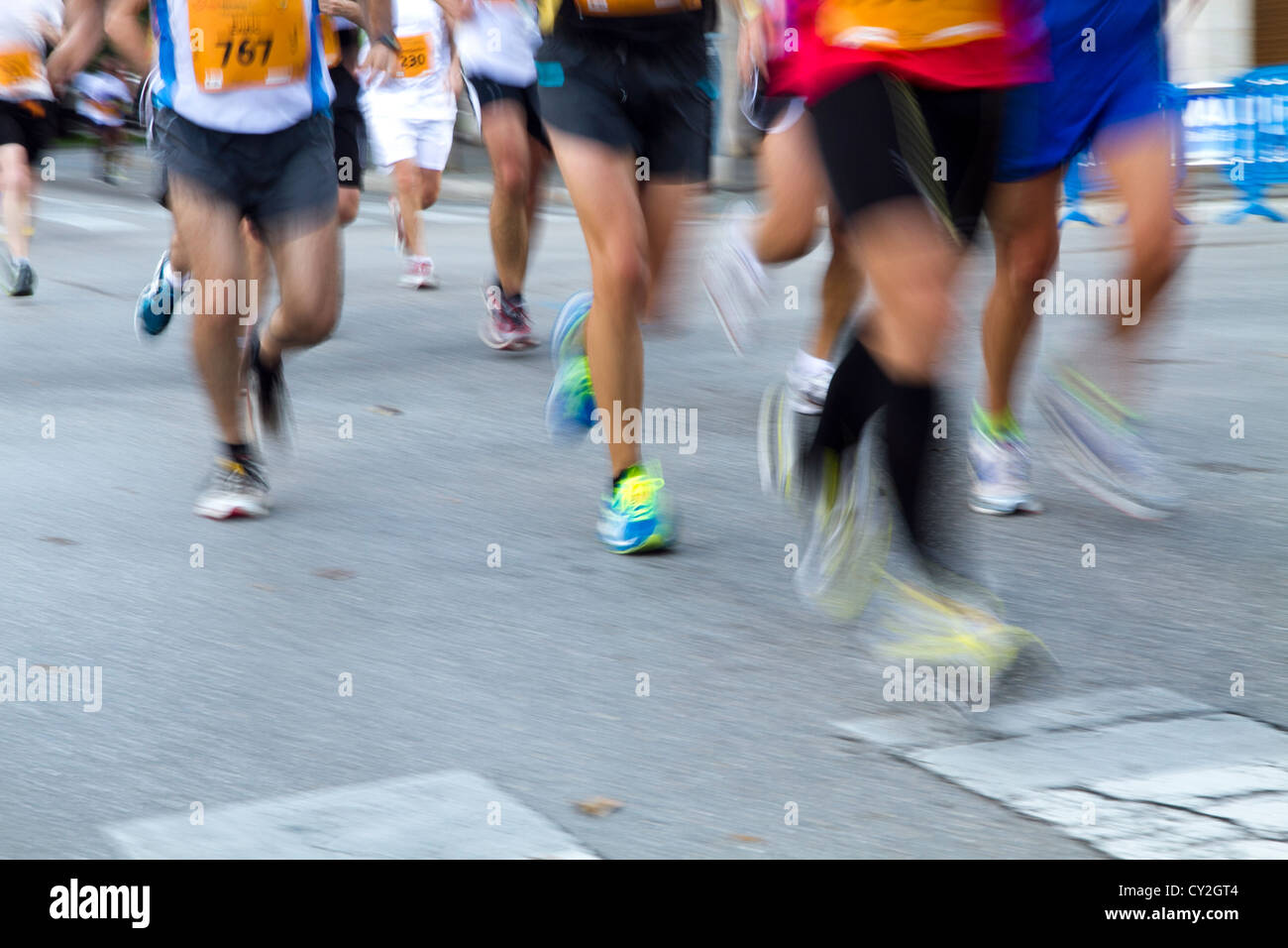 Marathon runners racing legs blurred motion athletes running on road ...