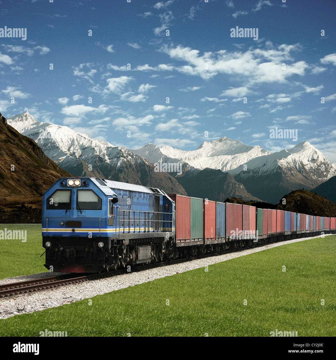 A Freight Train with Mountains Stock Photo - Alamy