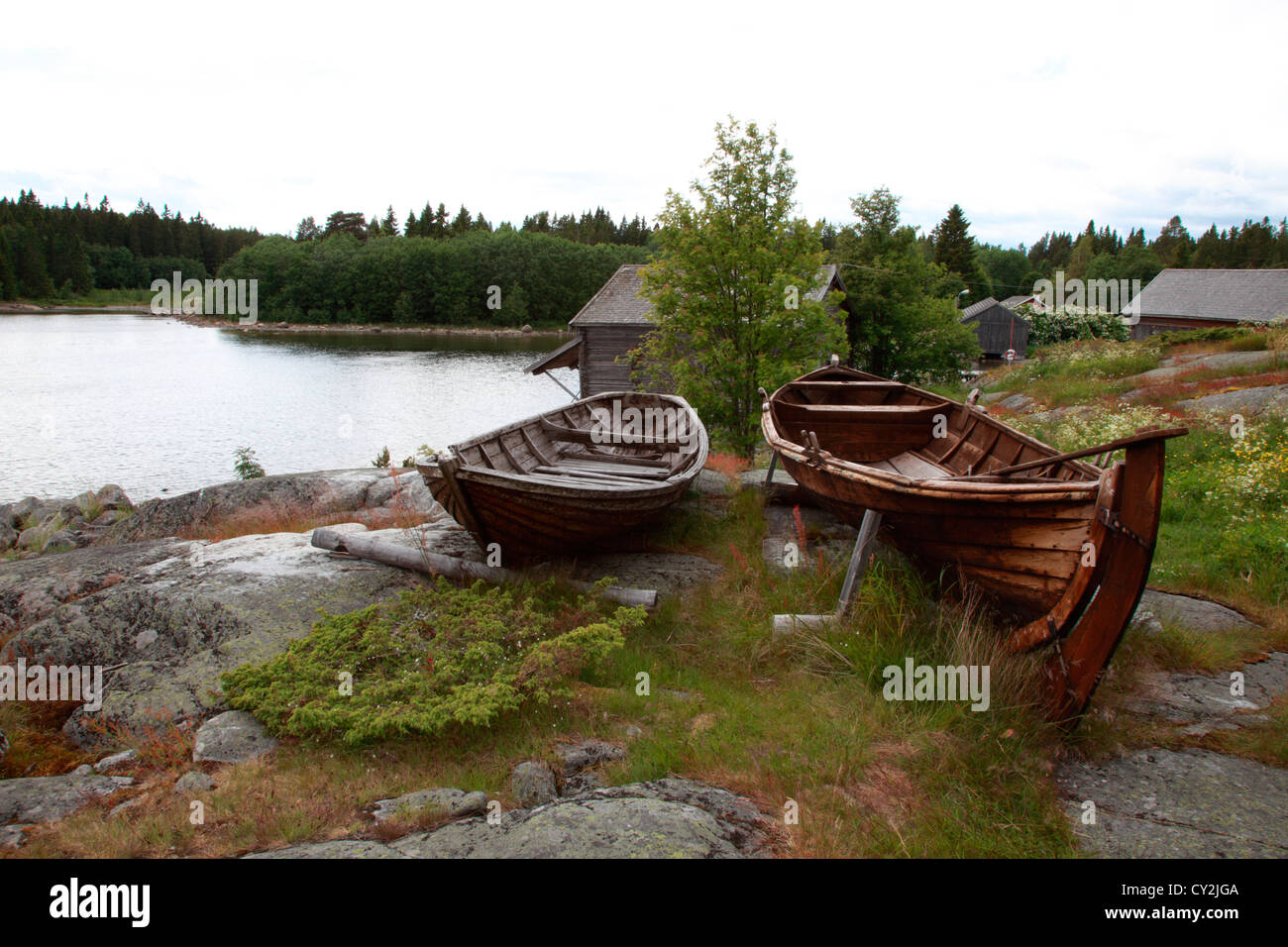 Old wooden boat houses and traditional rowing boats at a bay of the ...