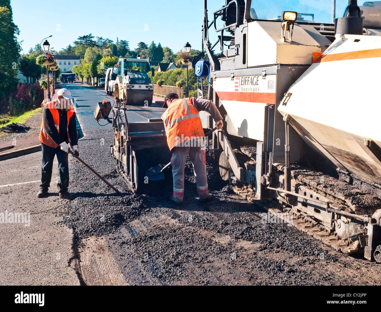 Workmen spreading tarmac / tarmac laying machine in operation - France ...