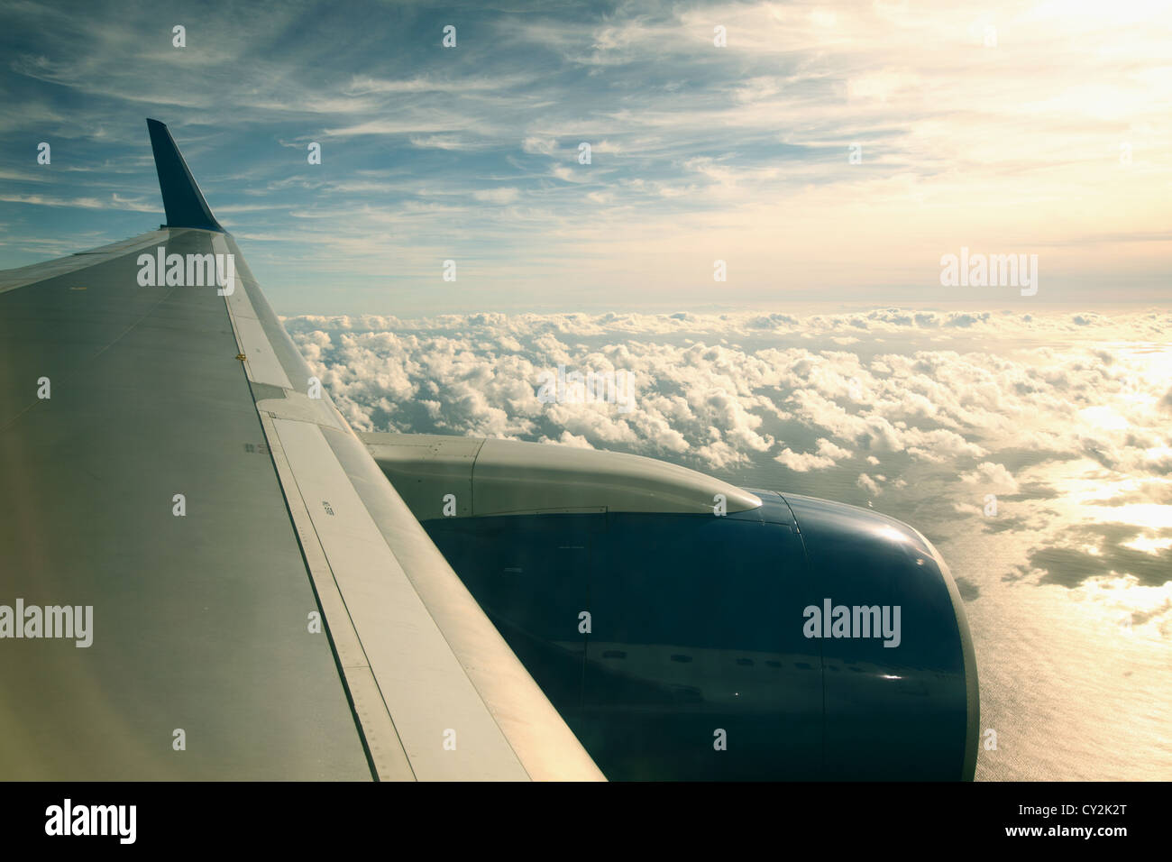 airplane fly in blue sky cloud around Stock Photo - Alamy