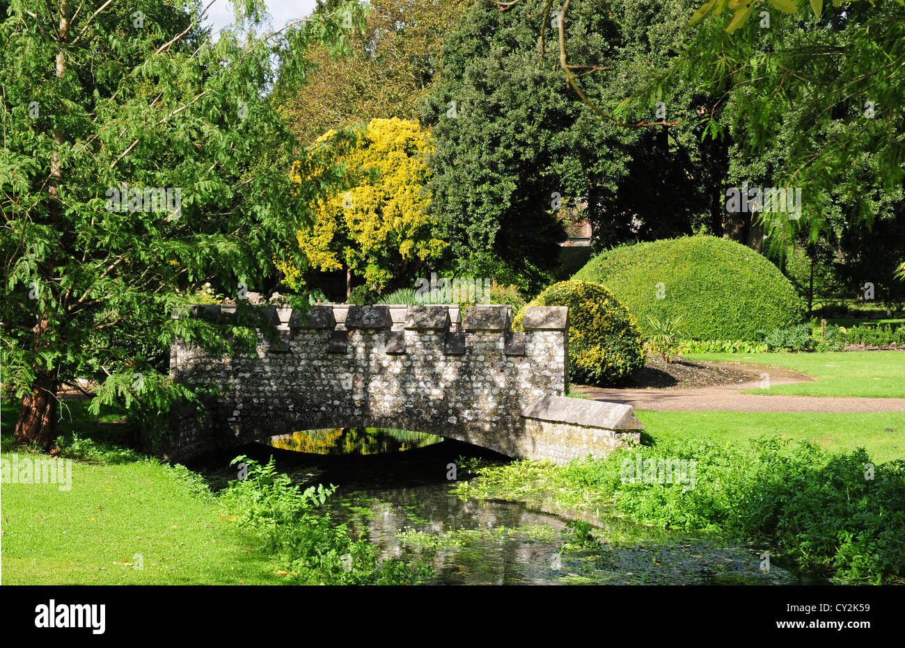 Flint bridge over the River Lavant, West Dean College Gardens Stock ...