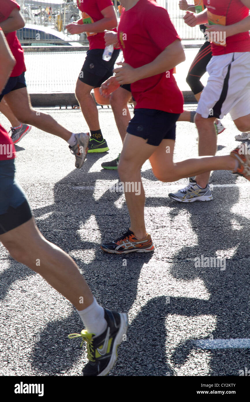 Marathon runners legs athletes running racing on road Stock Photo - Alamy
