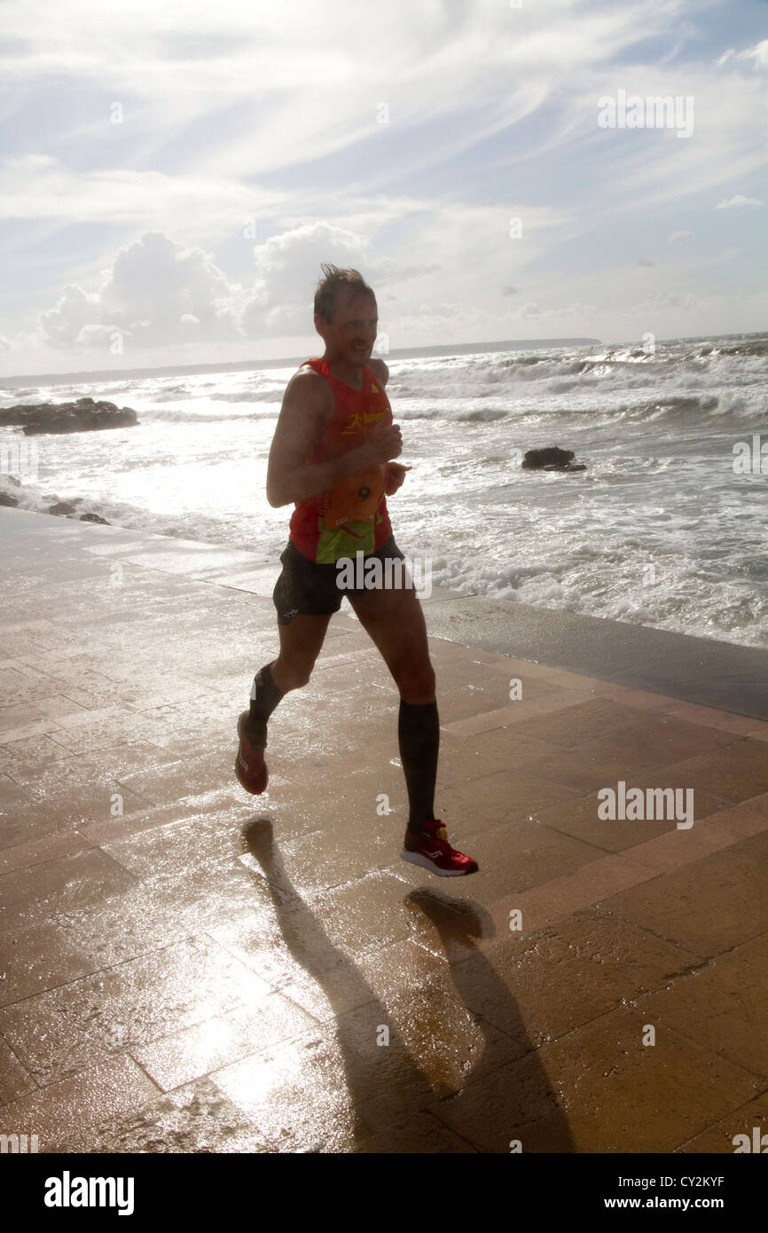 Marathon runner man race athlete running on promenade sea Palma de ...
