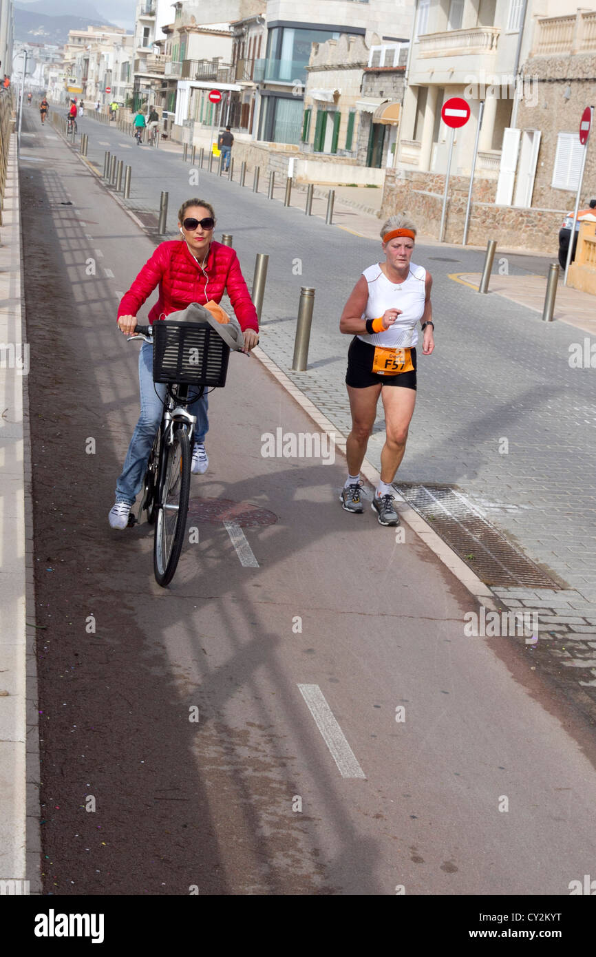 Marathon runner woman race athlete running on track Palma de Mallorca ...