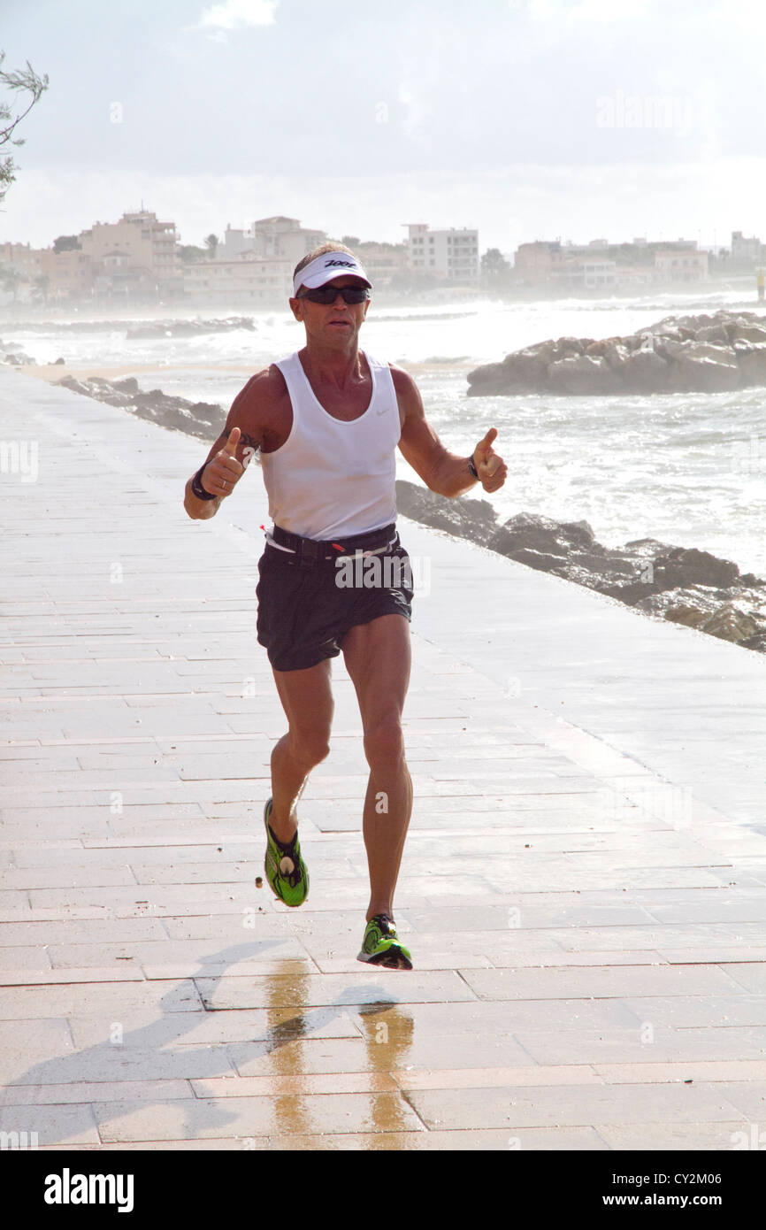Marathon runner man race athlete running on promenade sea road Palma de ...