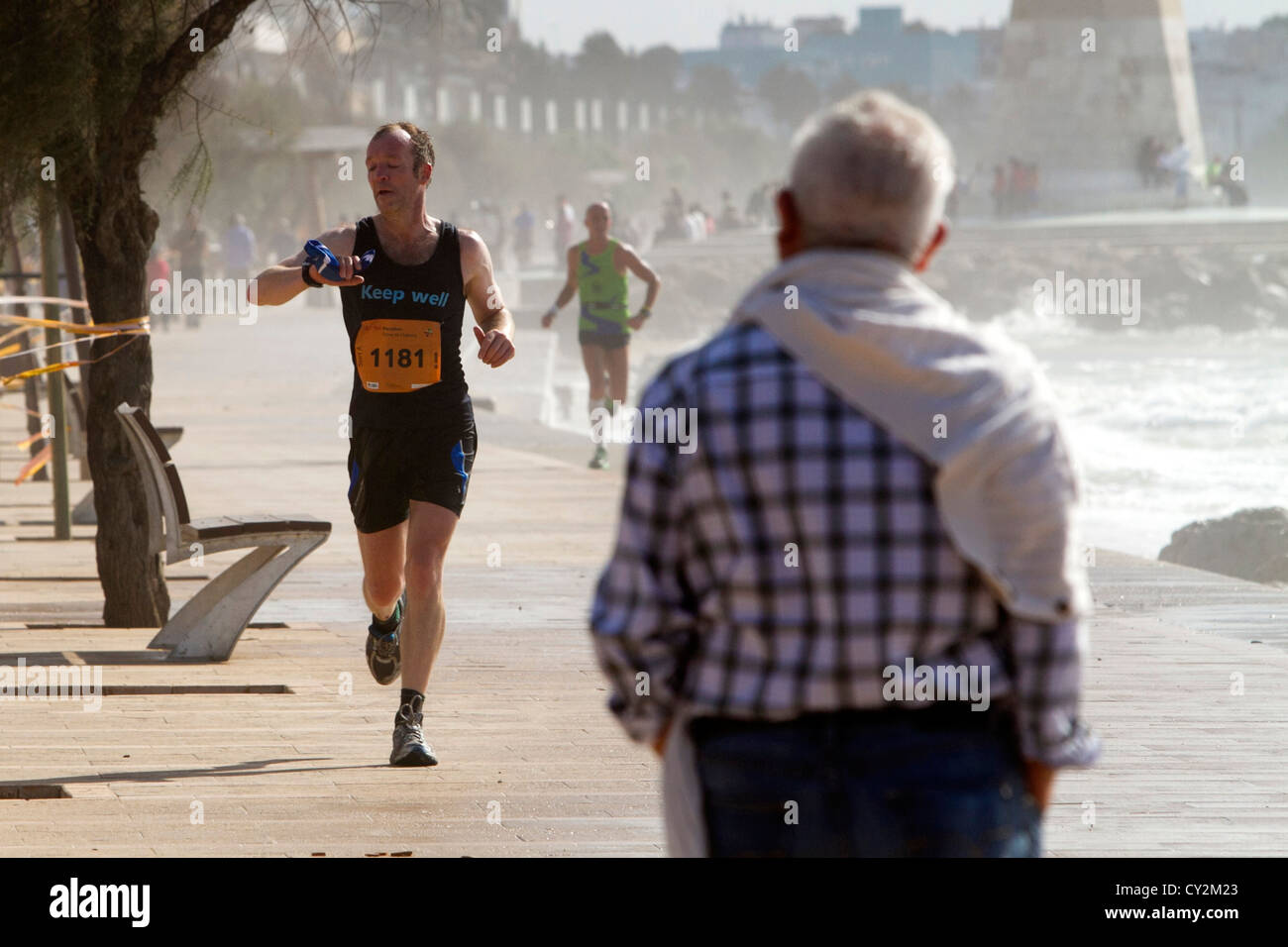 Marathon runner man race athlete running on promenade sea road Palma de ...