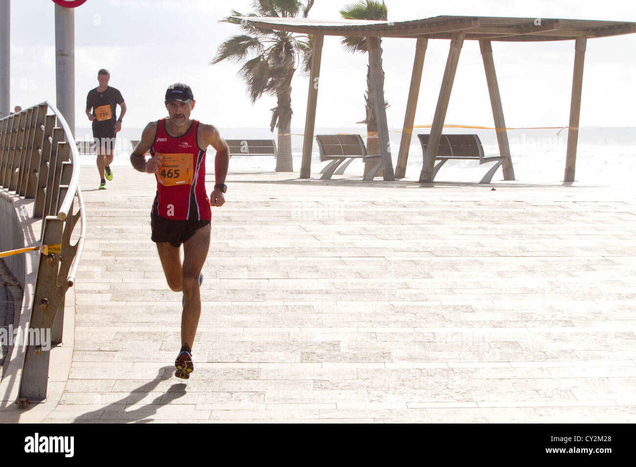Marathon runner race athlete running on promenade sea road Palma de ...