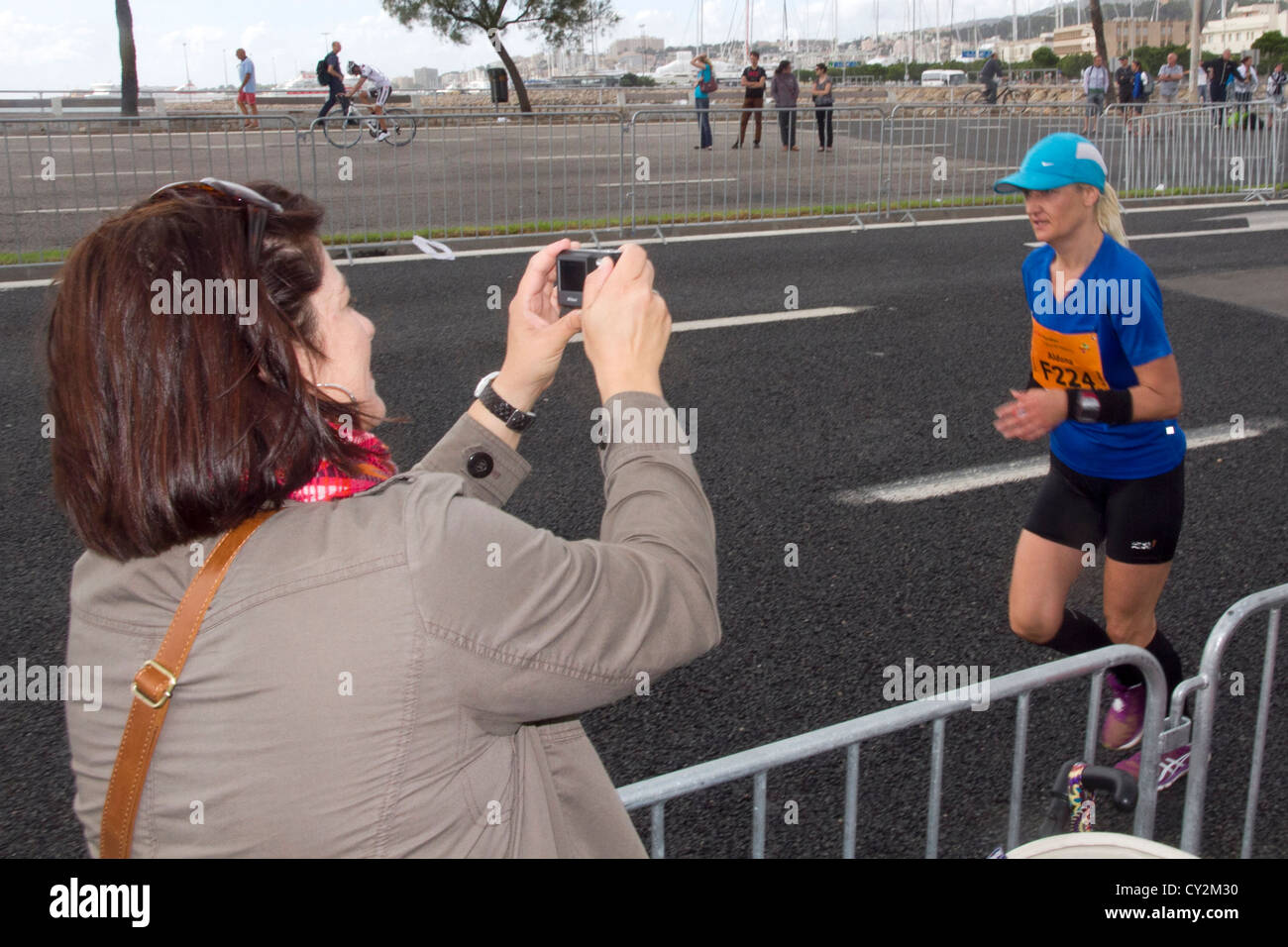 Marathon woman runner supporter race athlete running on road Palma de ...