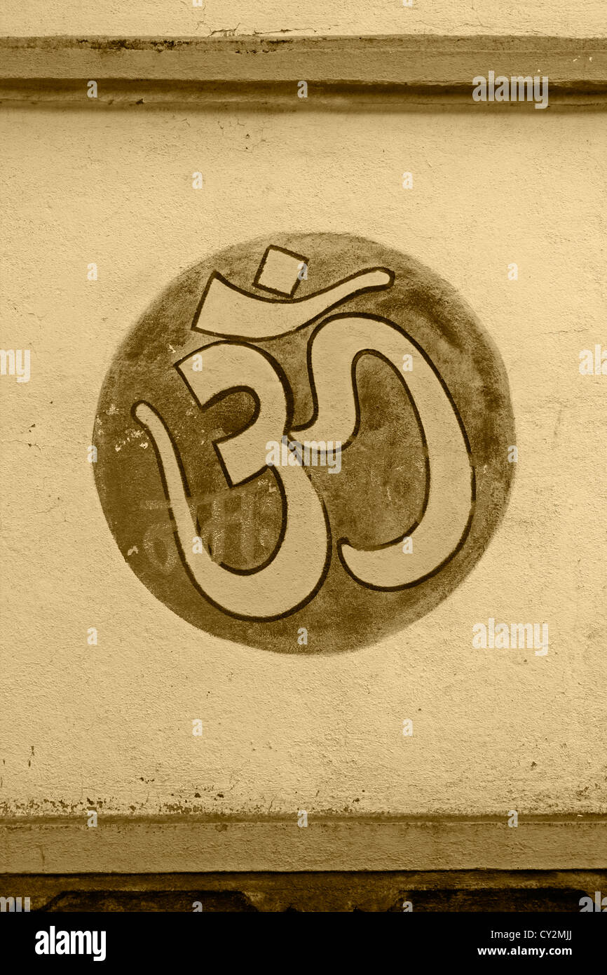 A holy sign called om is painted on front side of a Hindu temple ...