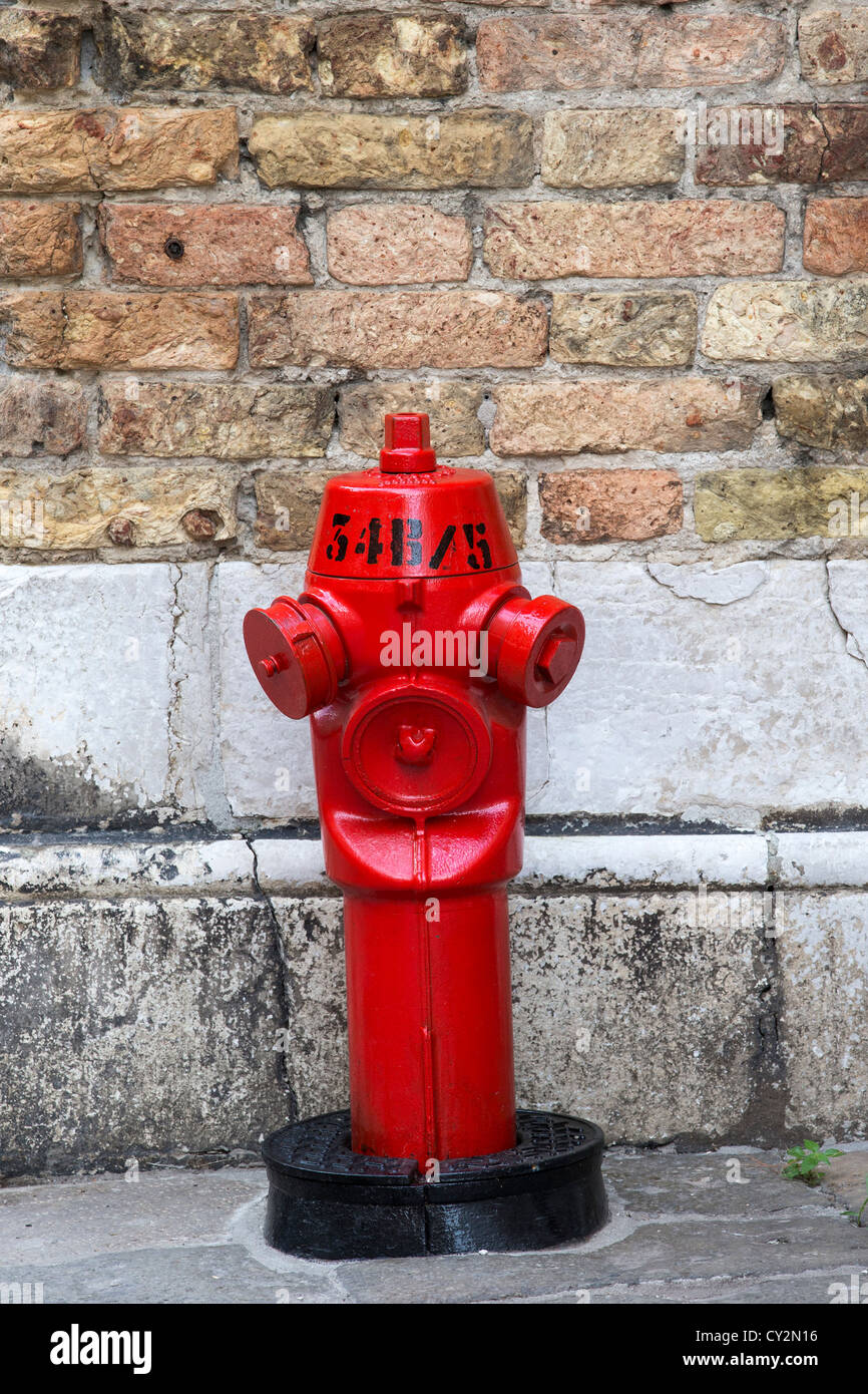 A red fire hydrant on the streets of Venice, Italy Stock Photo - Alamy