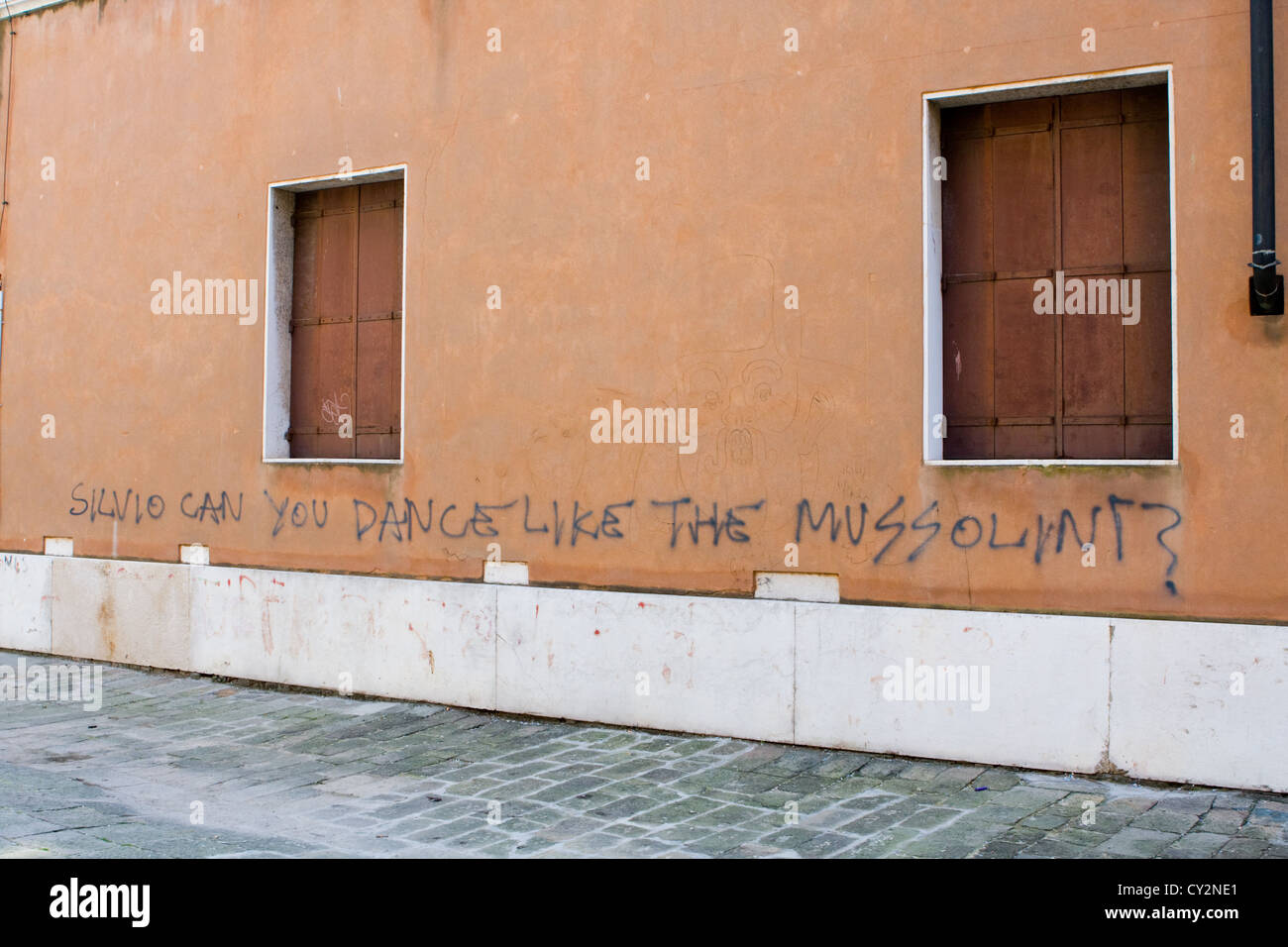 "Silvio can you dance like mussolini" graffiti on a wall with two ...