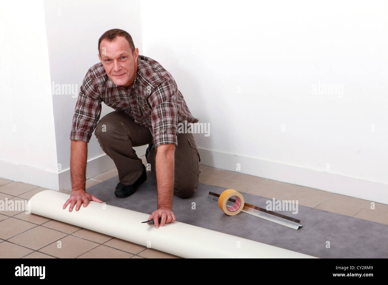 Man laying carpet Stock Photo - Alamy