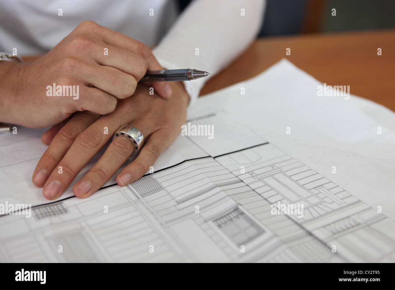 Married woman's hands resting on an architect drawing Stock Photo - Alamy