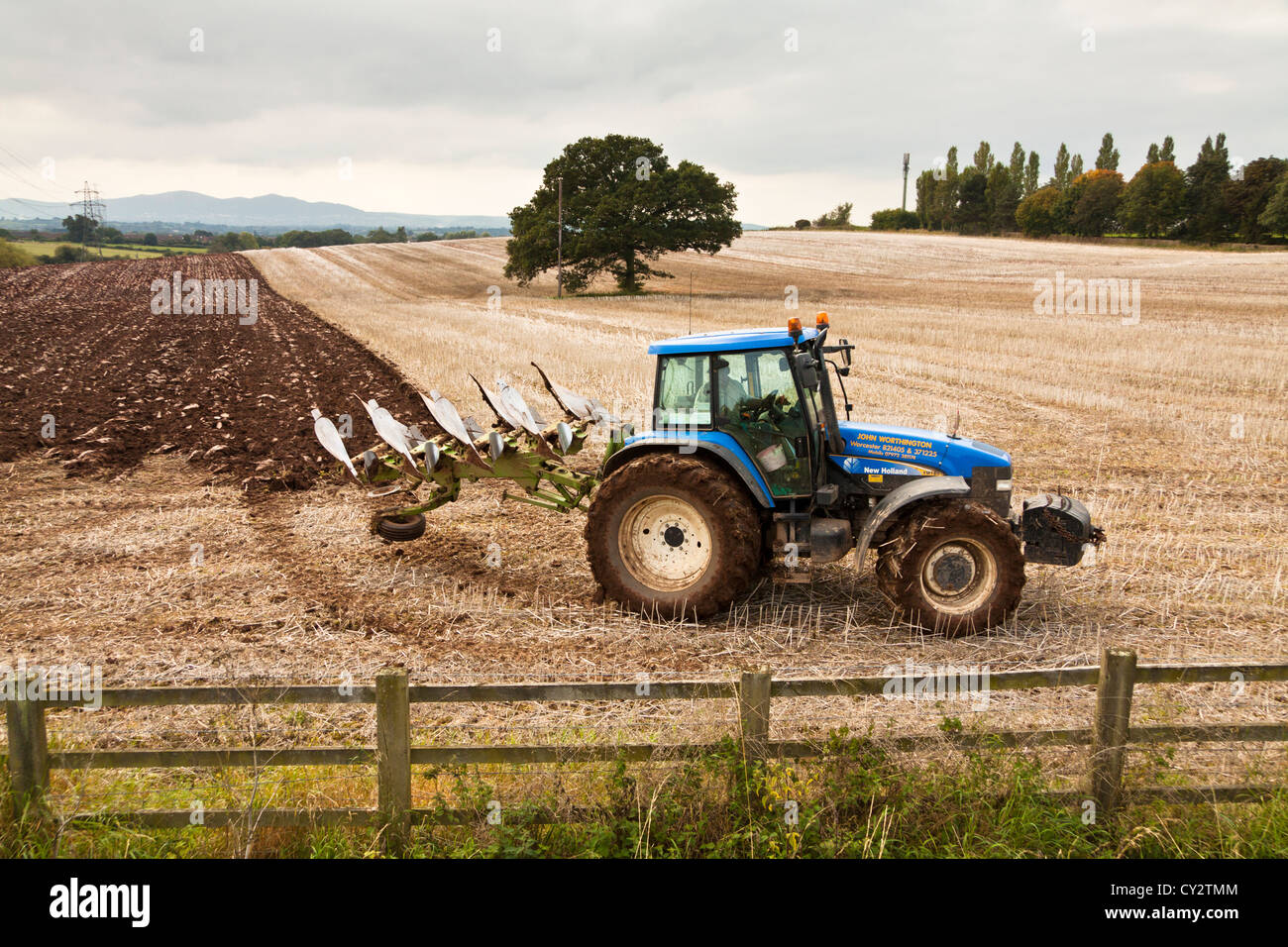 a tractor ploughing a field near Malvern hills Worcestershire.landscape ...