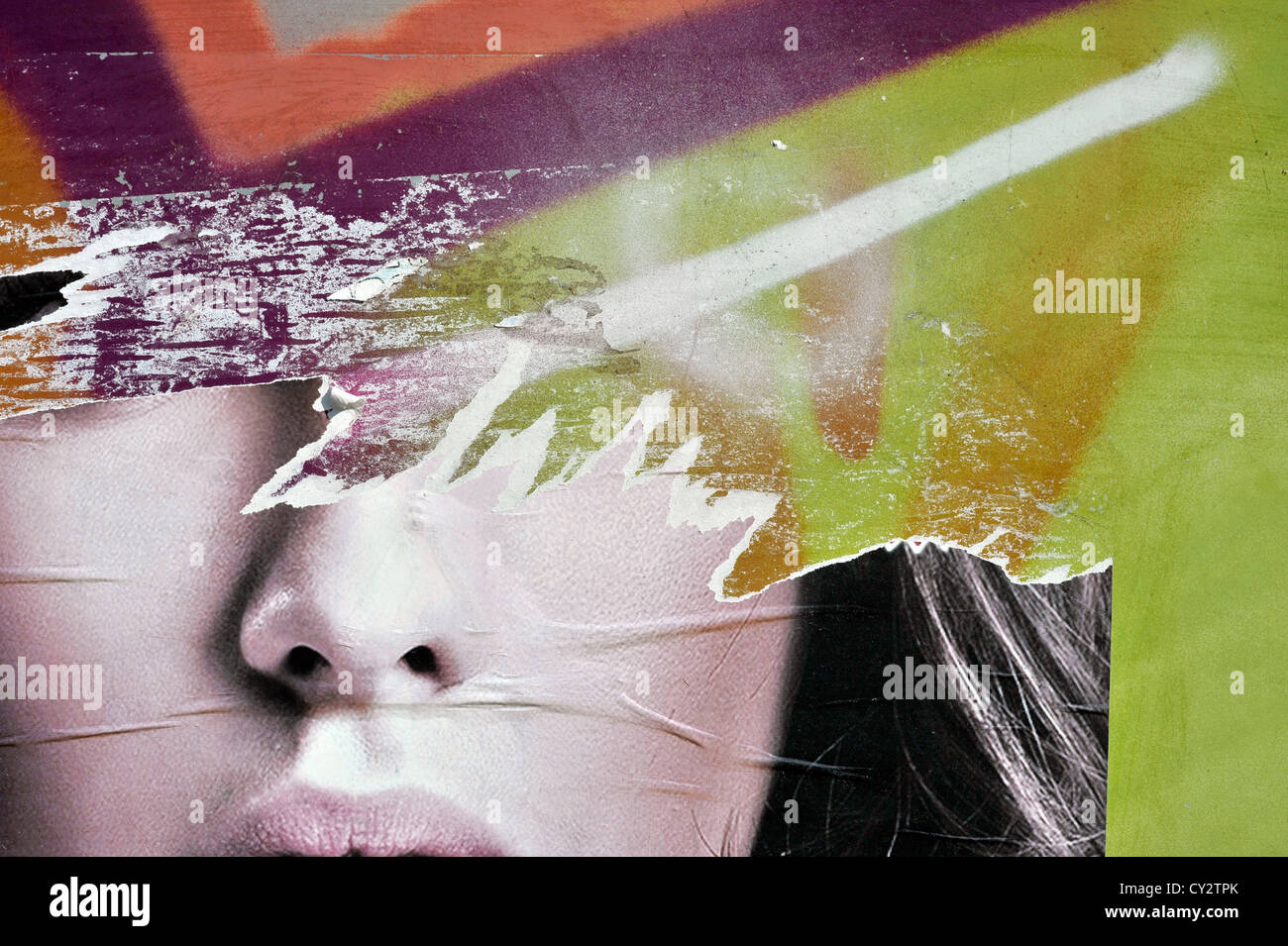 torn poster of female face graffit in background Stock Photo - Alamy
