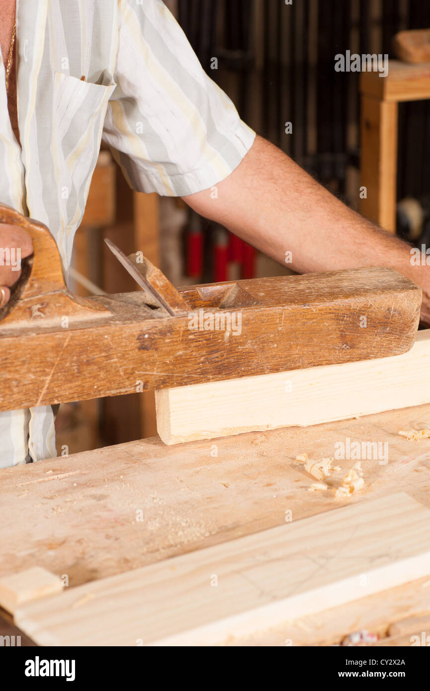 Old carpenter plane in action Stock Photo - Alamy