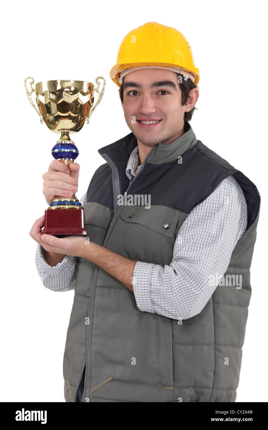 Construction worker with a trophy Stock Photo - Alamy