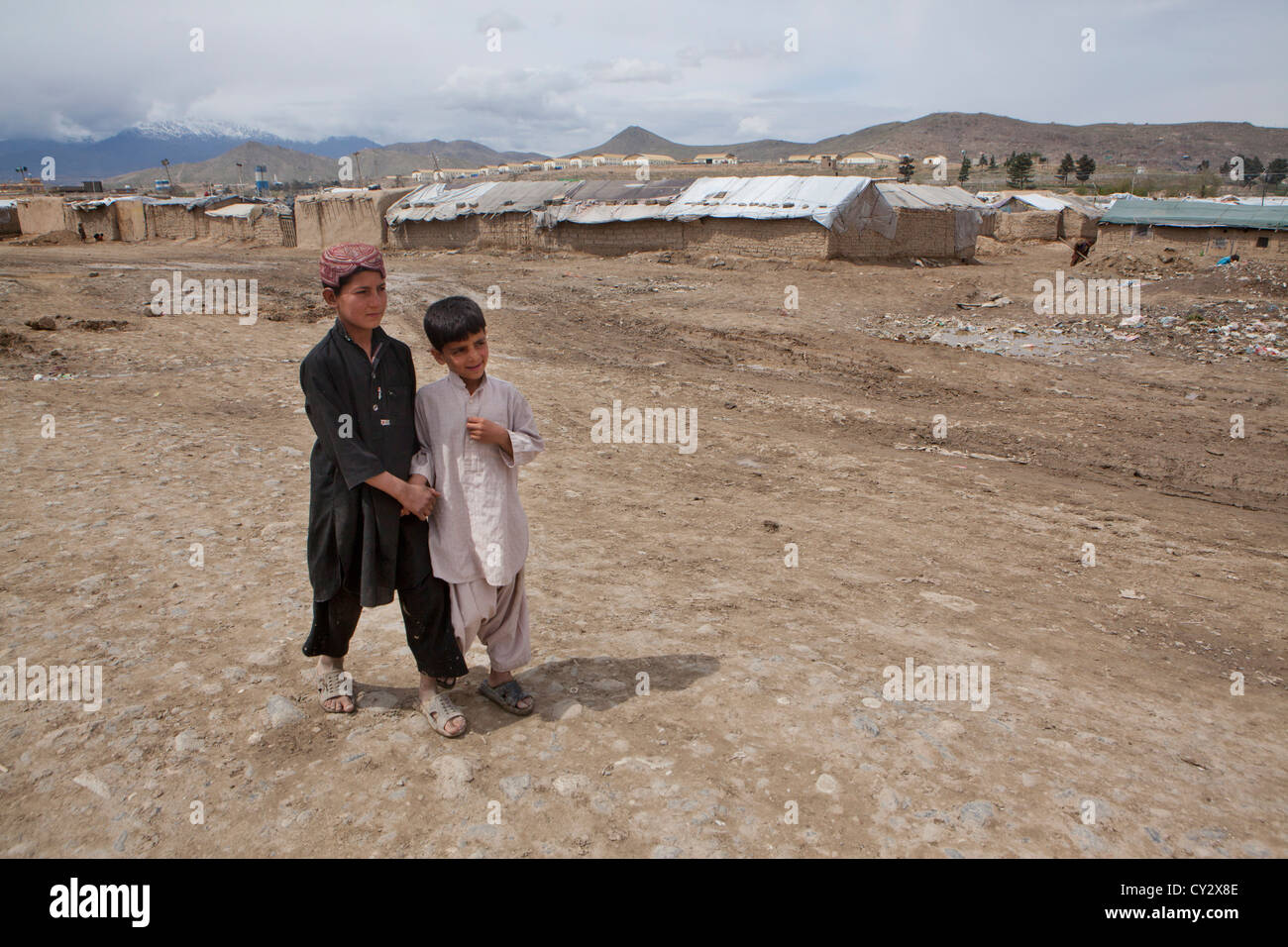 Afghan boy walking in a slum of kabul Stock Photo - Alamy