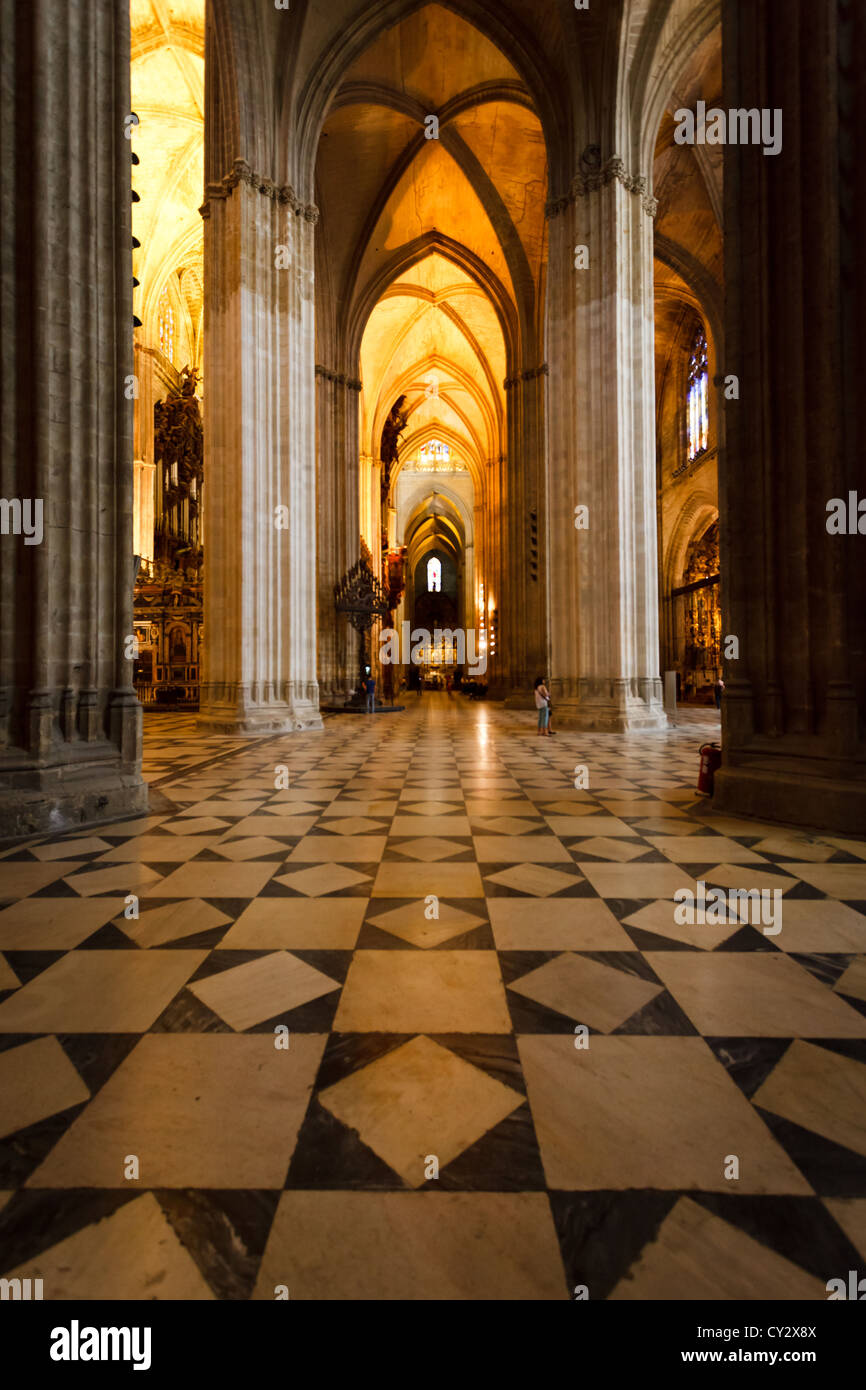 Interior view of illuminated long side chapel corridor in cathedral ...