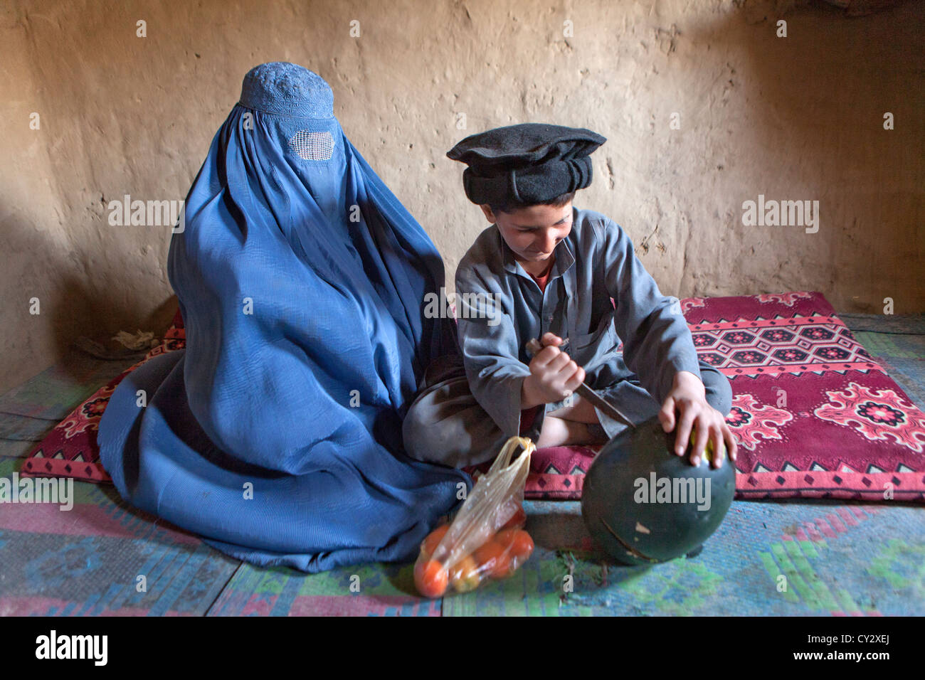 Afghan boy with his mother in burka Stock Photo - Alamy