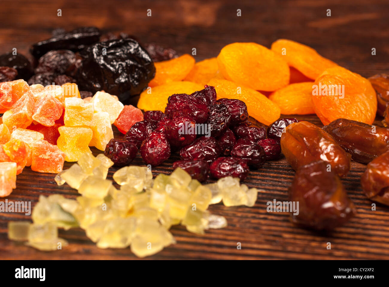 Assorted dried fruit displayed on an wooden surface Stock Photo - Alamy
