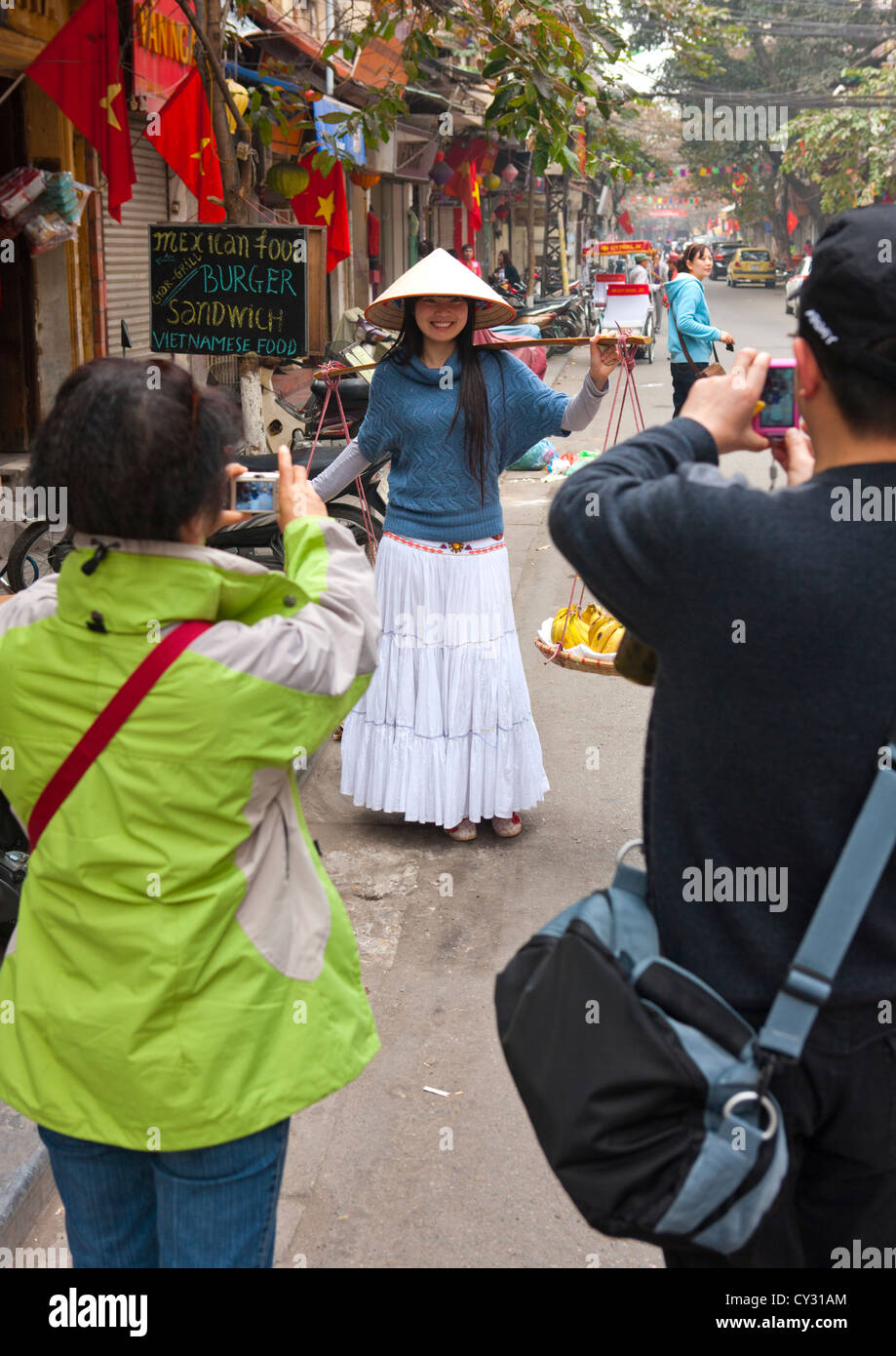 Couple Of Tourists Taking A Picture Of A Woman With A Sedge Hat, Hanoi ...