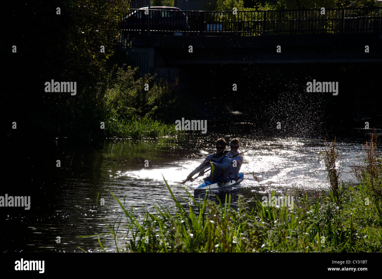 Two people paddling a kayak on the Union Canal near the centre of ...