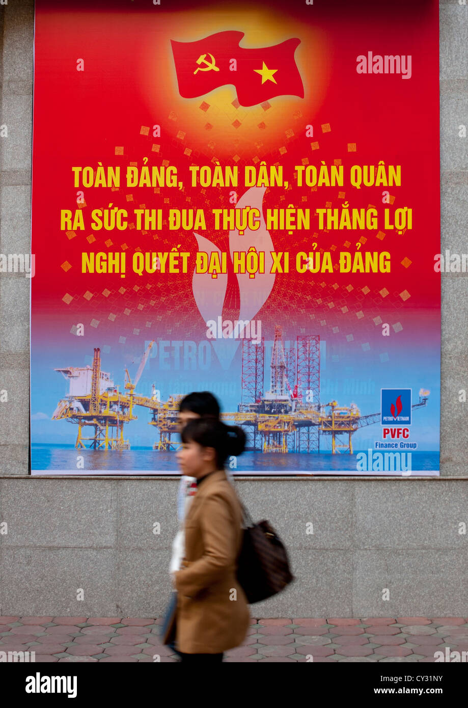 Couple Passing By A Propaganda Billboard Of The Communist Party, Hanoi ...