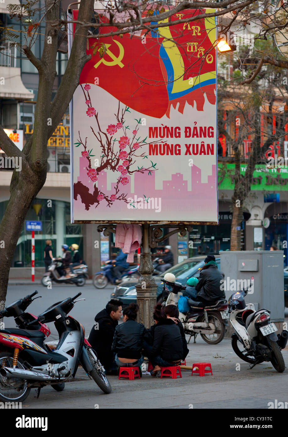 Teenagers Sitting Under A Propaganda Panel Of The Communist Party ...