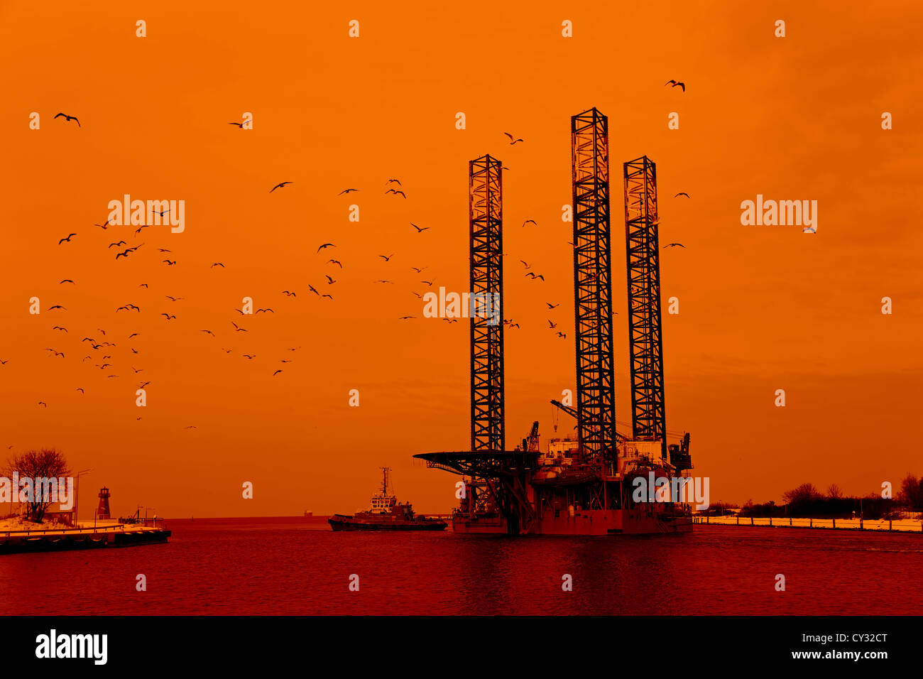 Oil rig at sunset background Stock Photo - Alamy