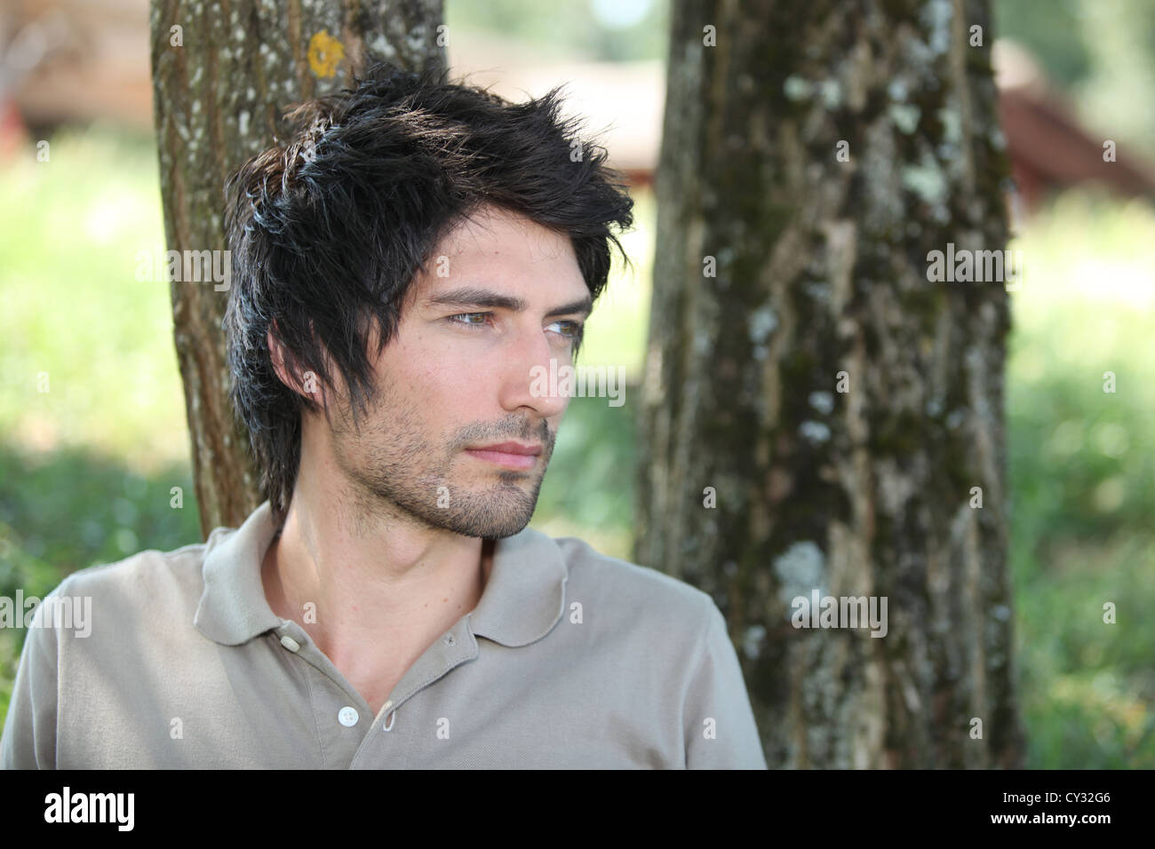Man sat in park thinking Stock Photo - Alamy
