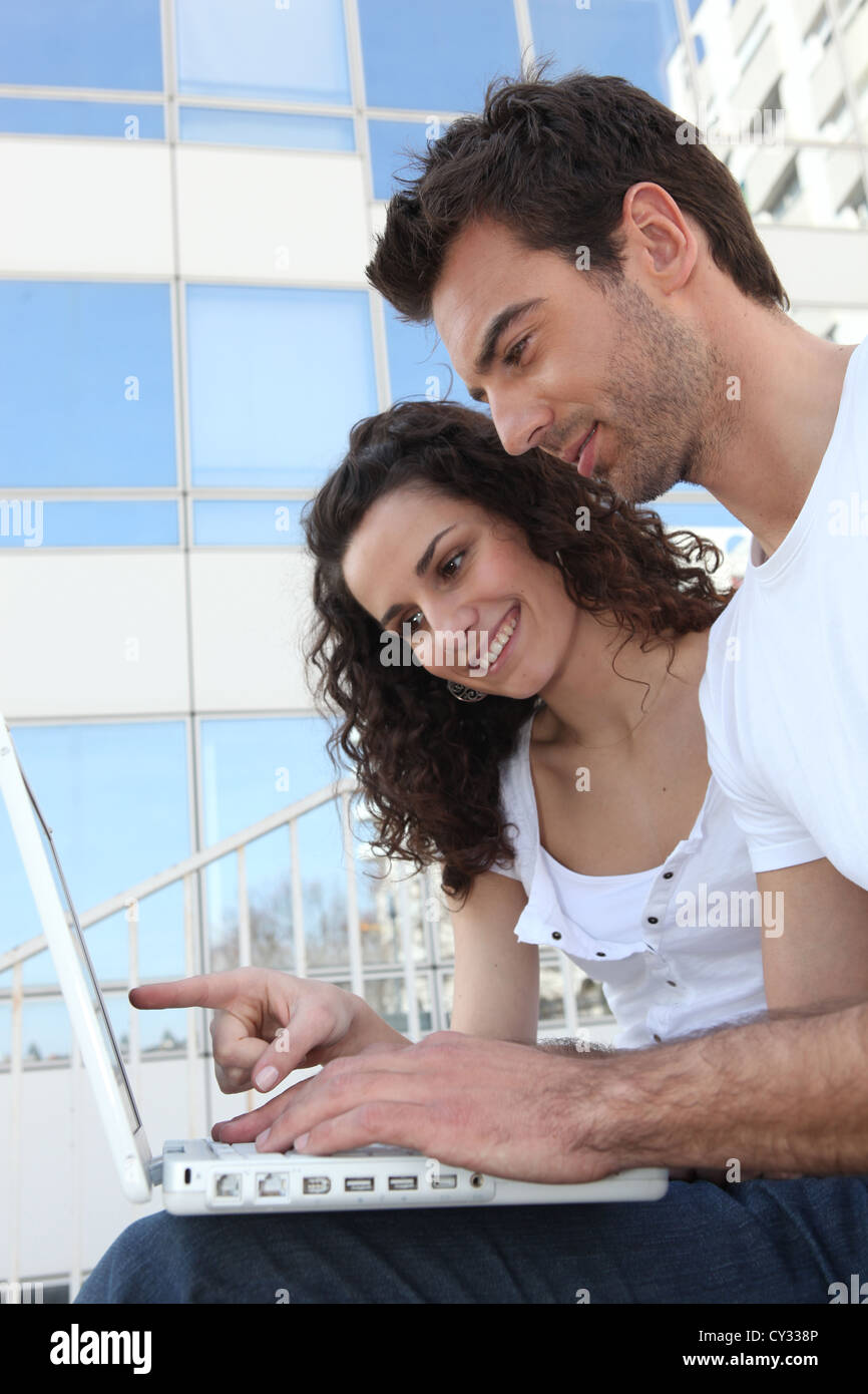 Couple with glass building in front of computer Stock Photo - Alamy