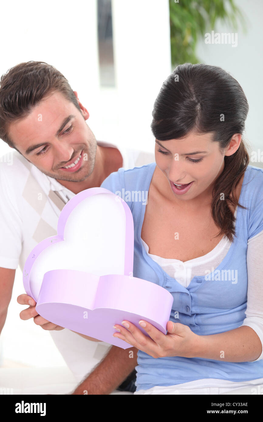 Woman opening gift Stock Photo - Alamy