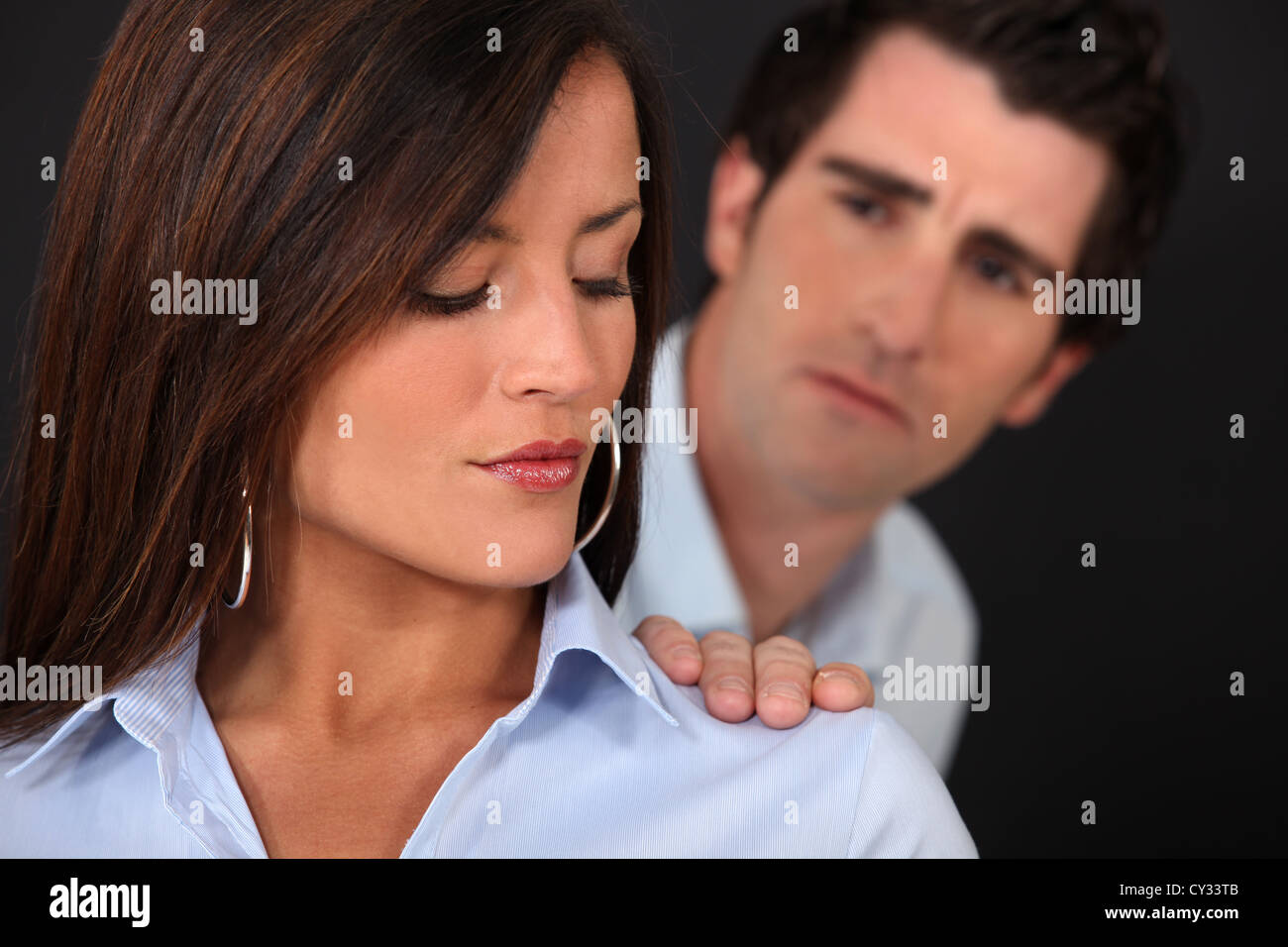 Concerned man touching his wife's shoulder Stock Photo - Alamy