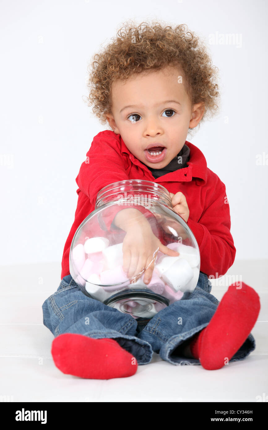 Baby eating sweets Stock Photo - Alamy
