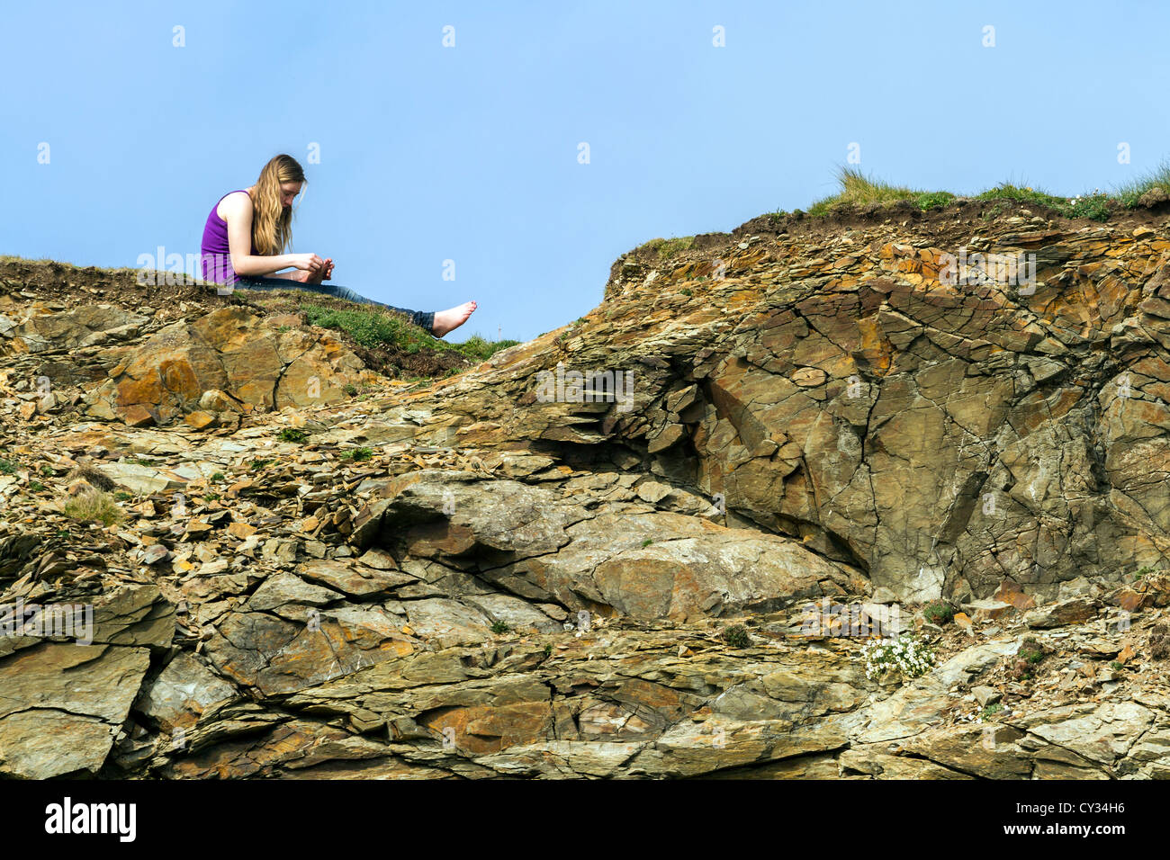 Girl on rocks Stock Photo - Alamy