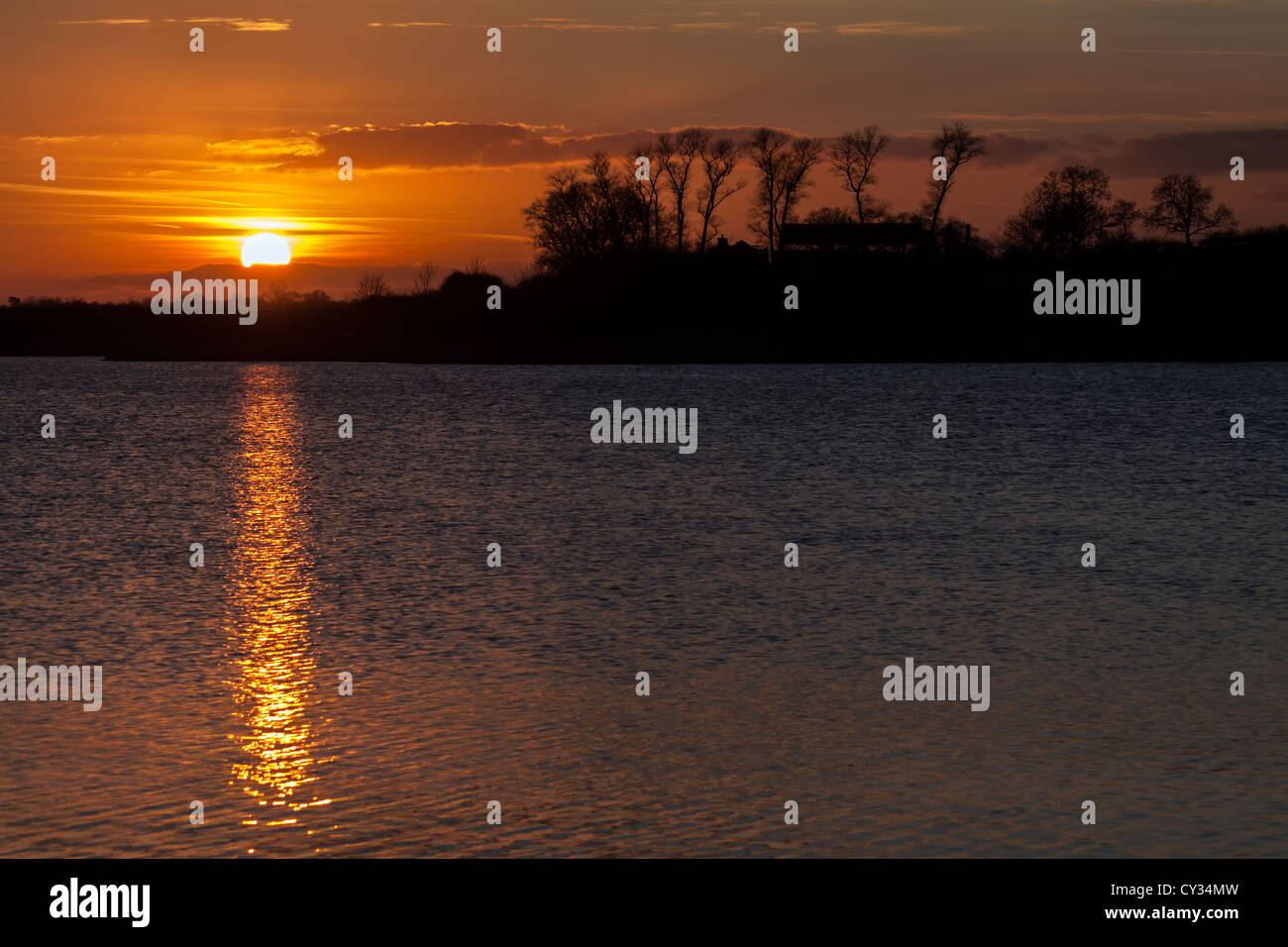 sunset over a lake Stock Photo - Alamy