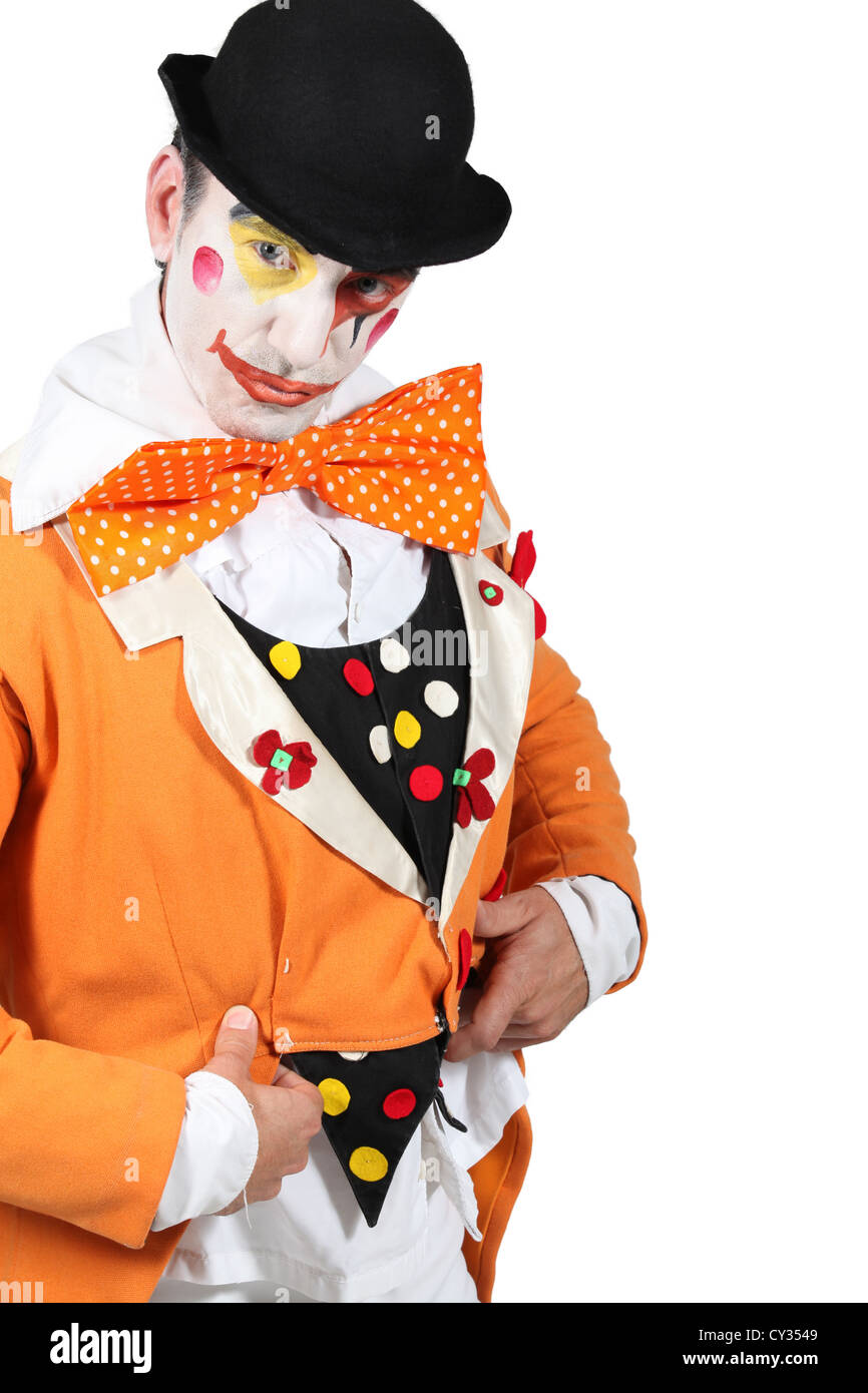 man maked up wearing a grotesque clown costume and a bowler Stock Photo ...