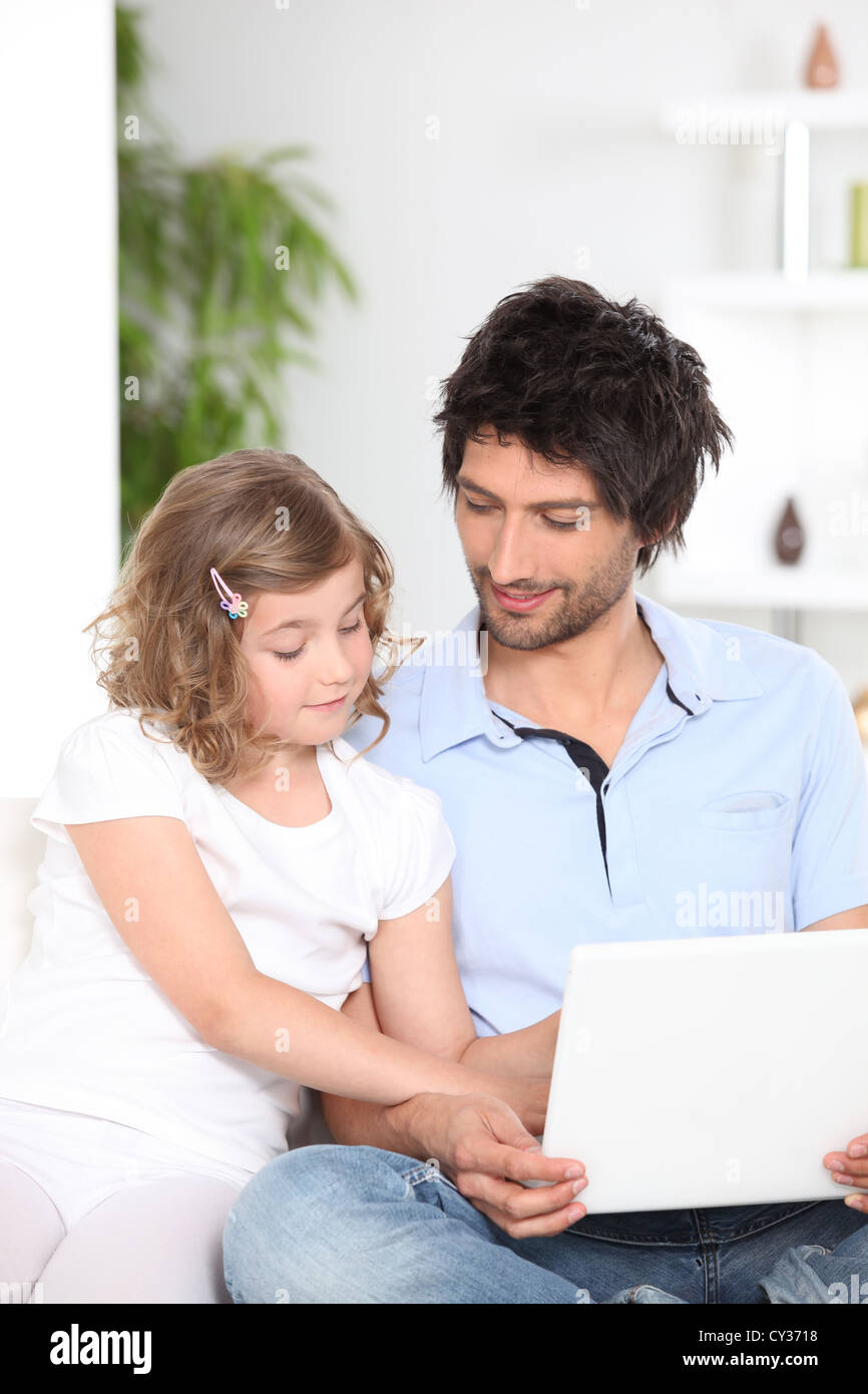 Father and daughter at home with a laptop Stock Photo - Alamy