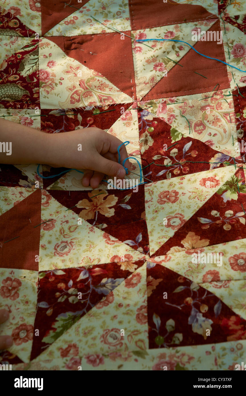 A Young hand Attempting to Quilt Stock Photo - Alamy