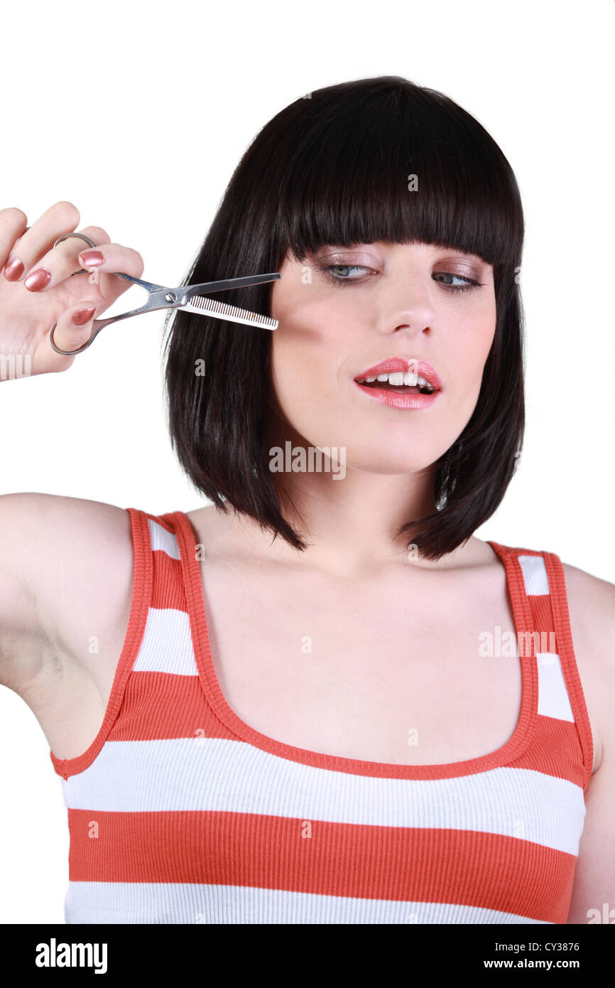 Young woman trimming her bangs Stock Photo - Alamy