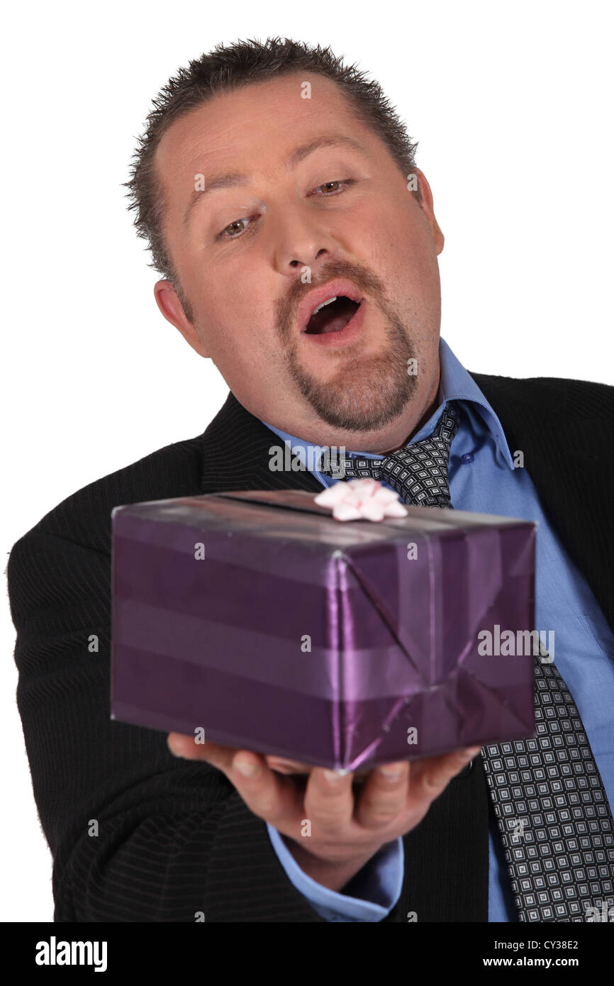 Man surprised at having received a gift Stock Photo - Alamy