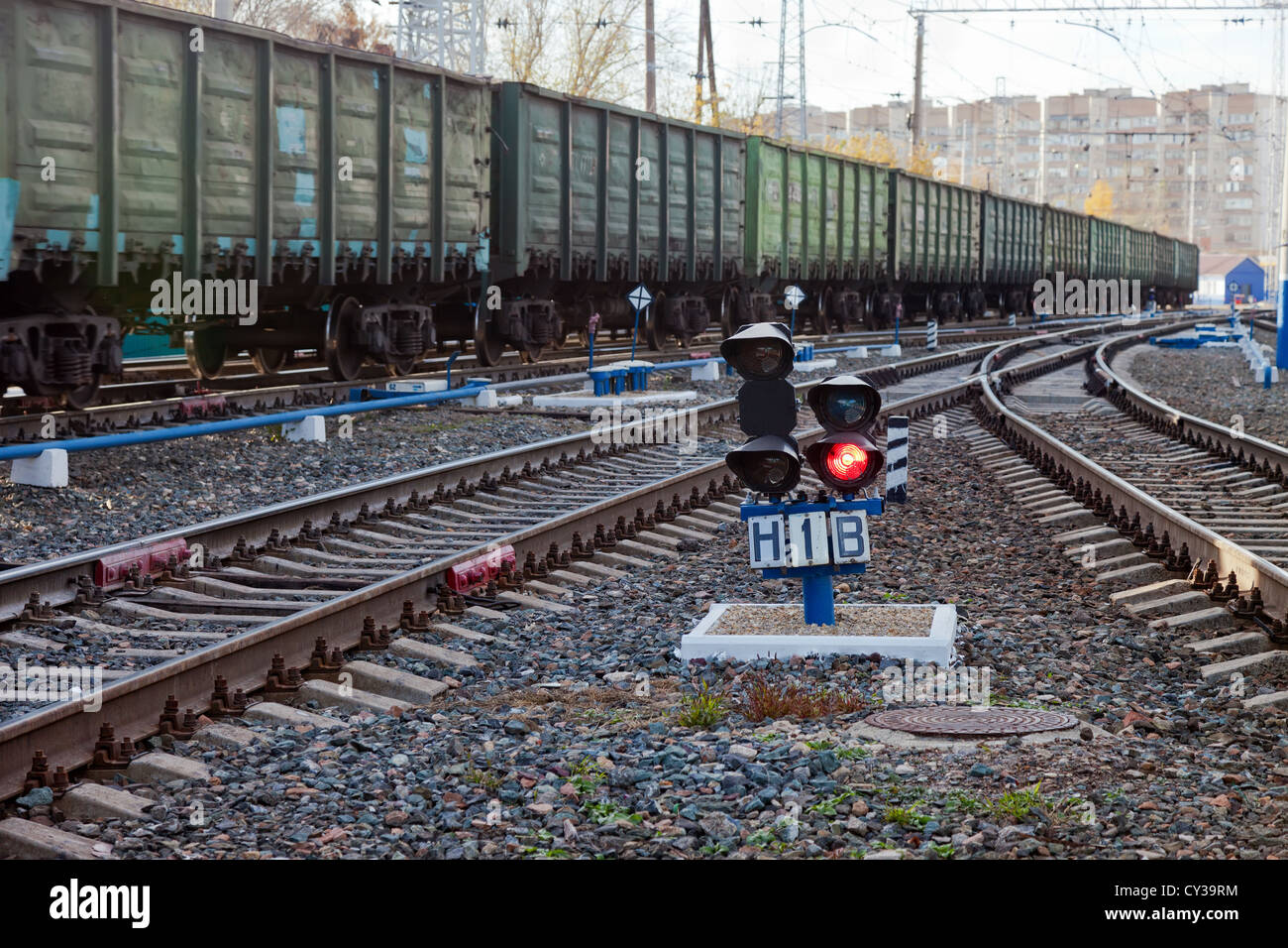 Train running on railway tracks near train station Stock Photo - Alamy