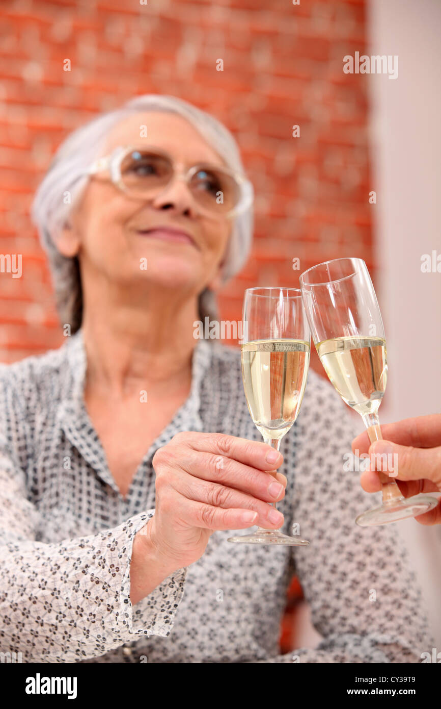 Woman toasting in restaurant Stock Photo - Alamy